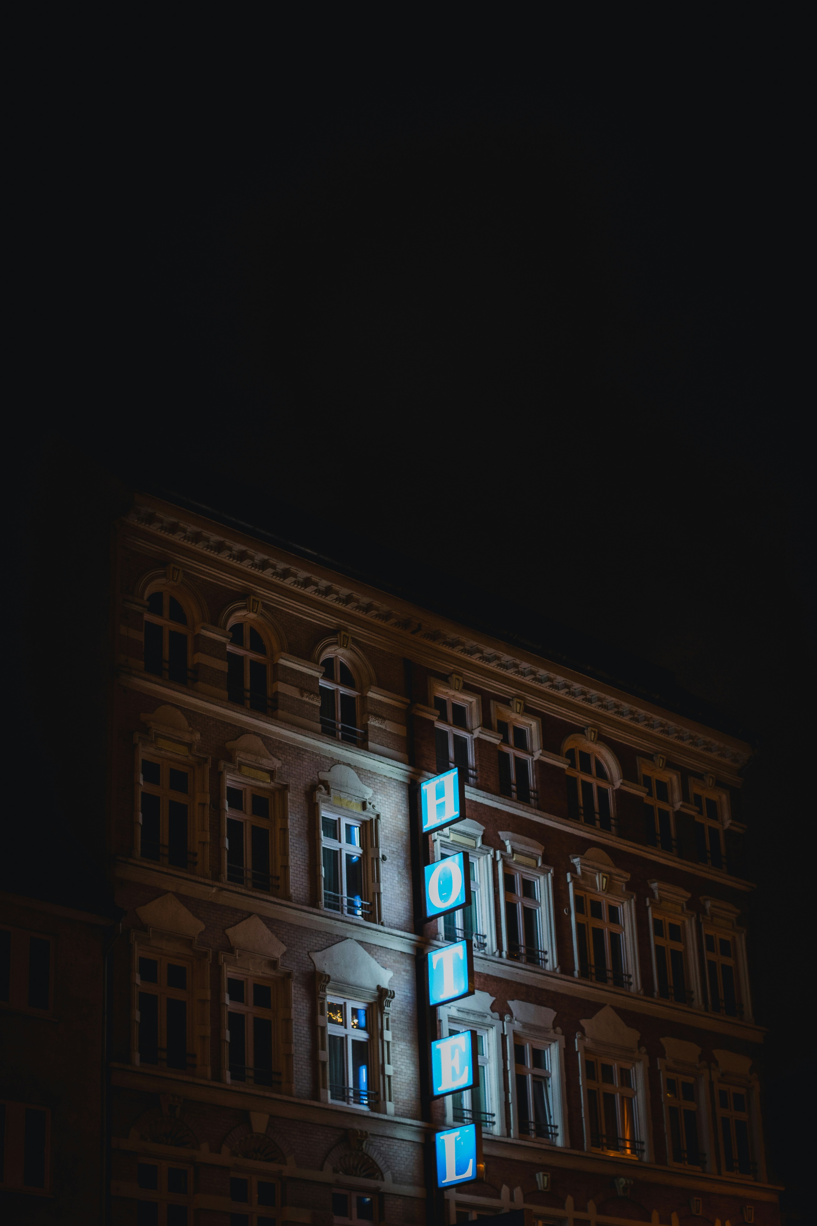 Blue Neon Hotel Sign Anchored by Historic Facade