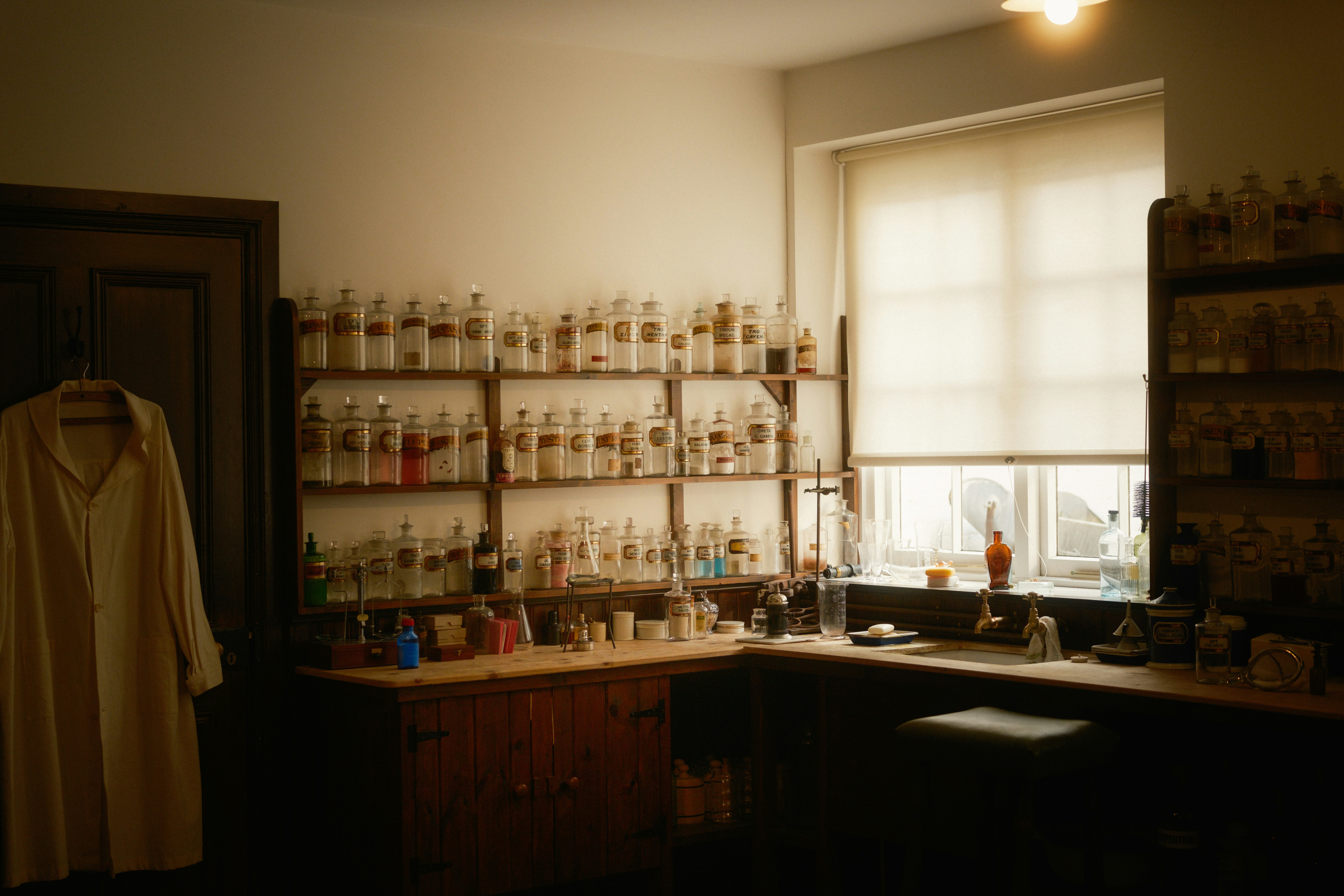 Dim Apothecary: bottles and window light in a silent backstage of a workshop