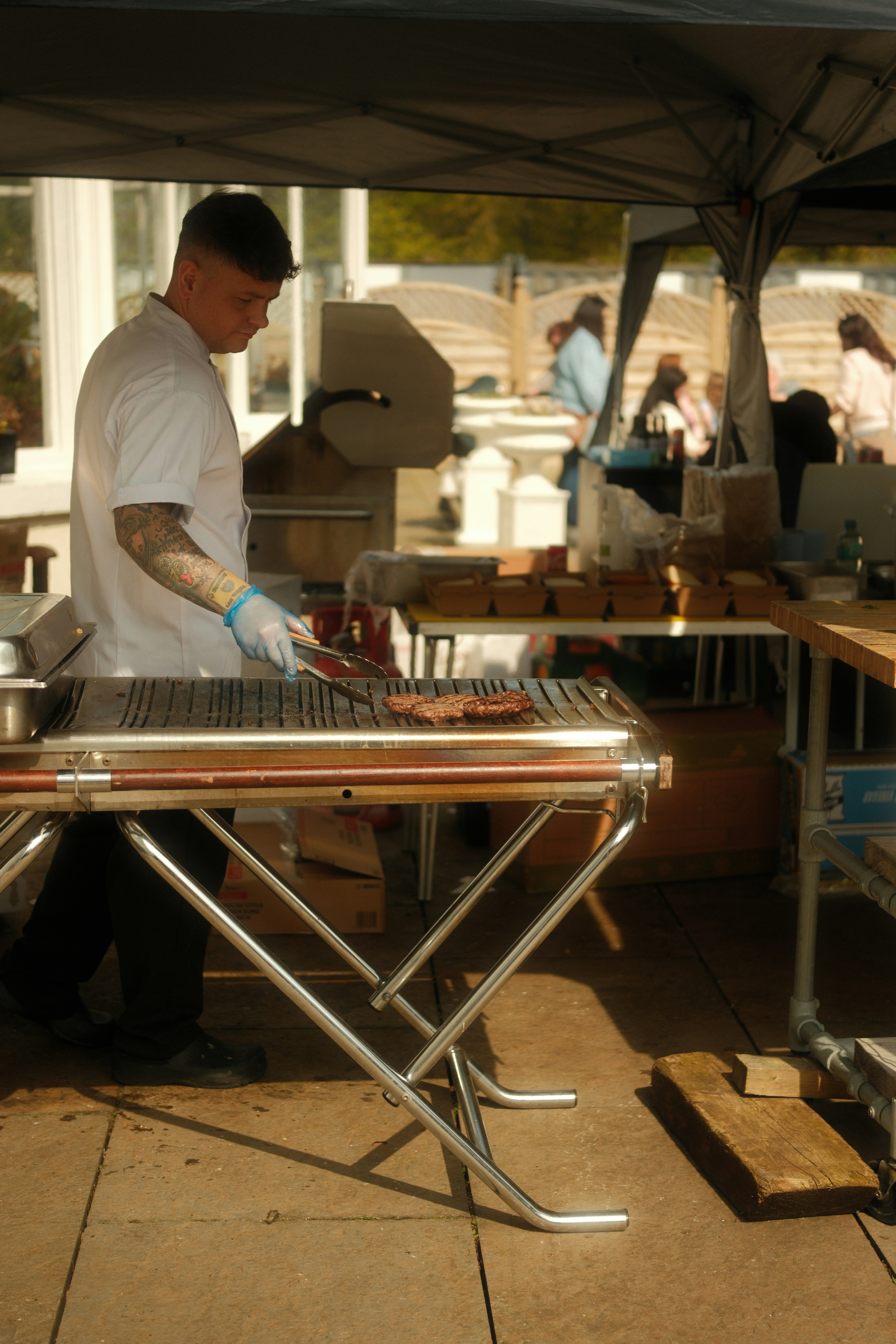 Grillmaster at the Tasting Tent: sizzling steaks under careful flame