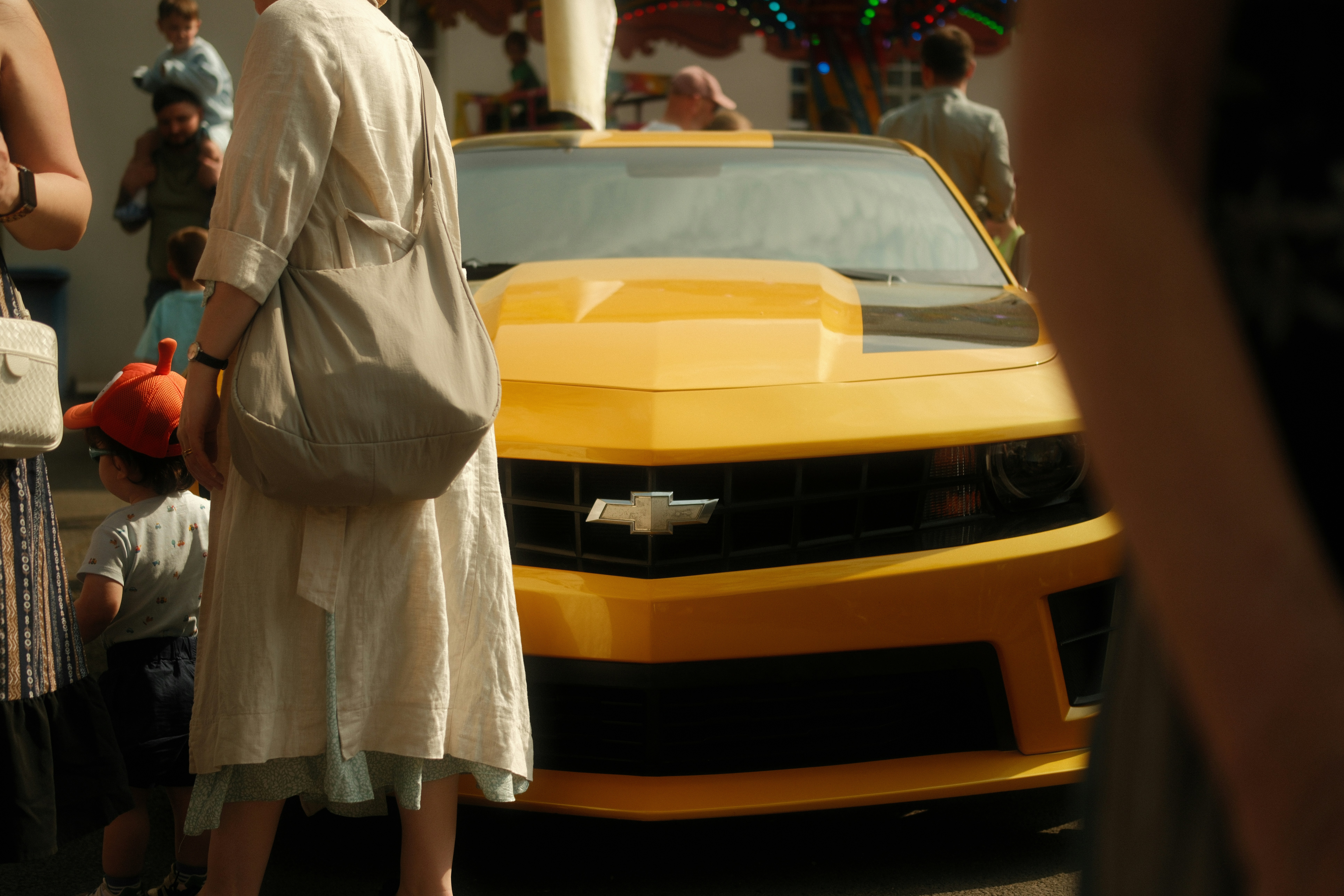 Yellow Chevy Stallion: A Busy Street Scene Framed by a Morning Parade