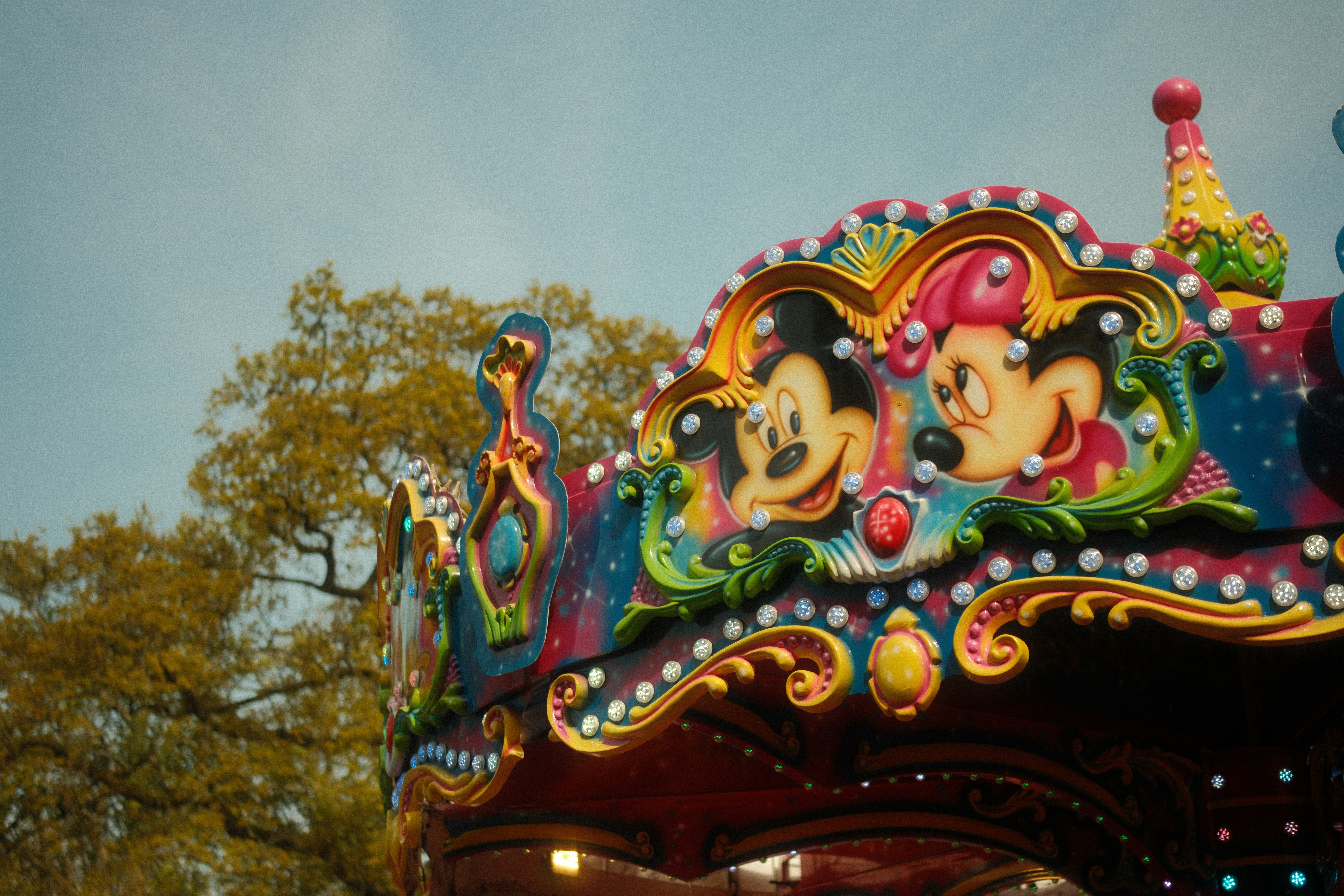 Mickey and Minnie Carousel Crest at a Sunlit Fairground