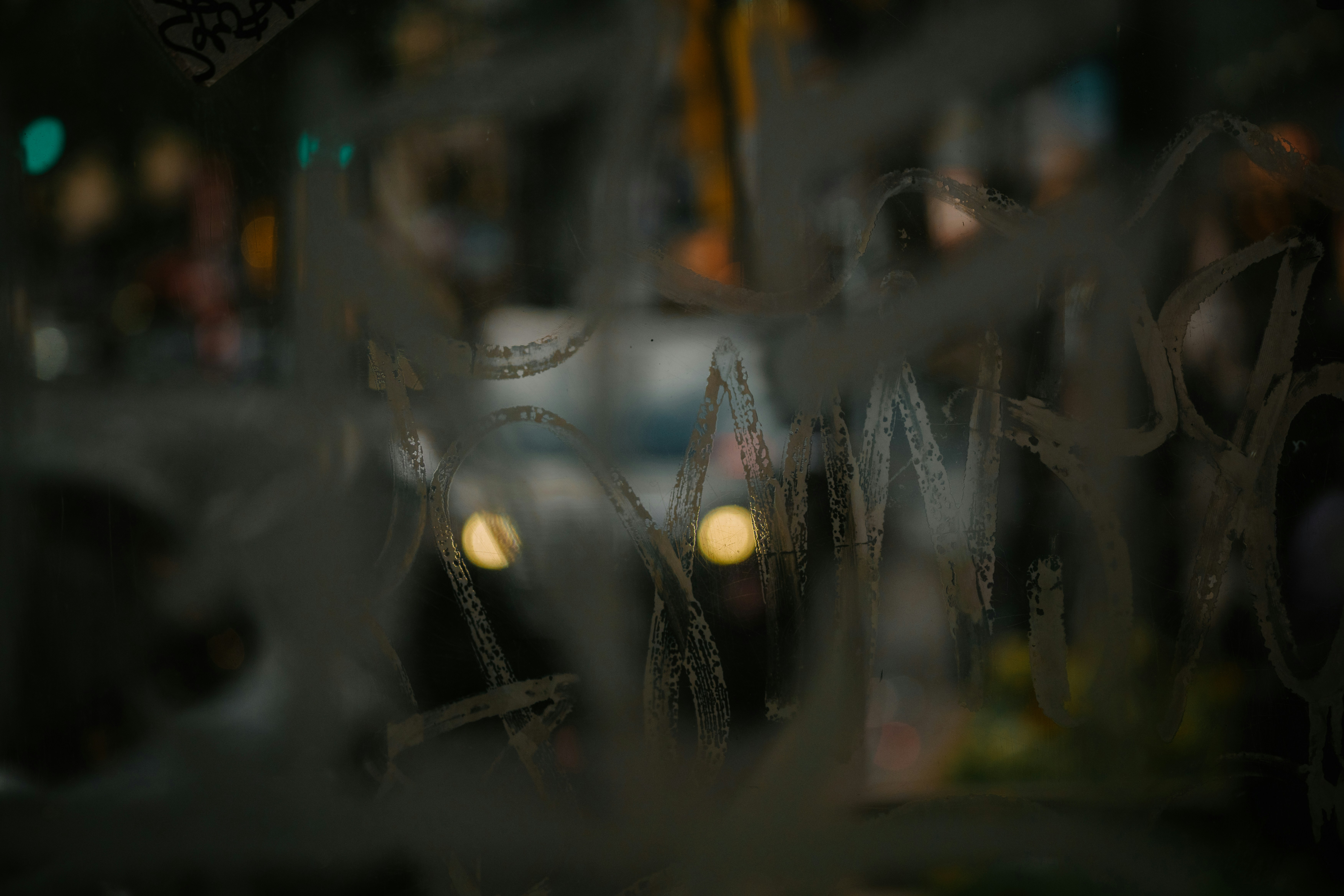 Out of Focus Through a Graffiti-Veiled Window