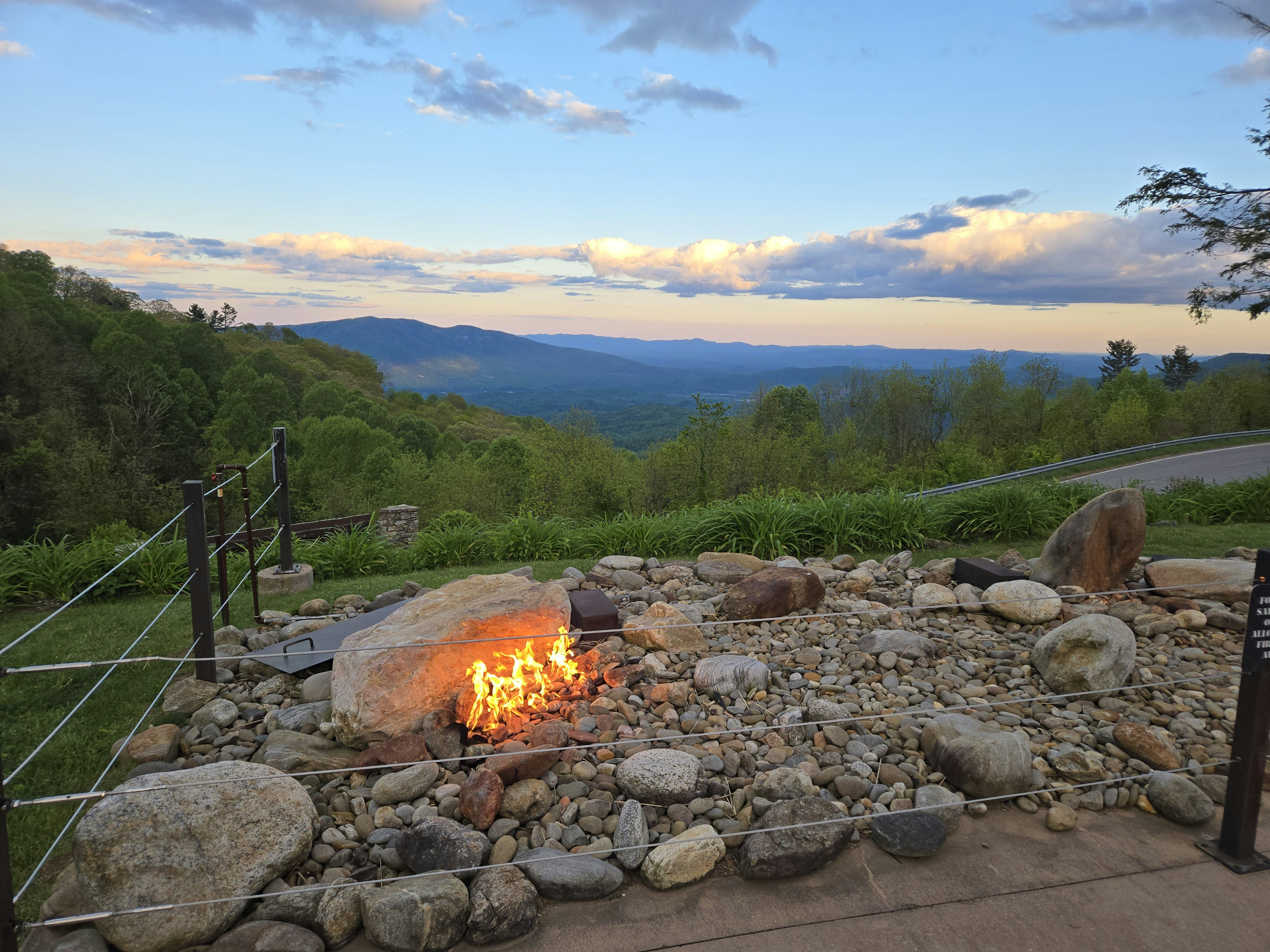 Firelit overlook: valley, rocks, and distant ridges