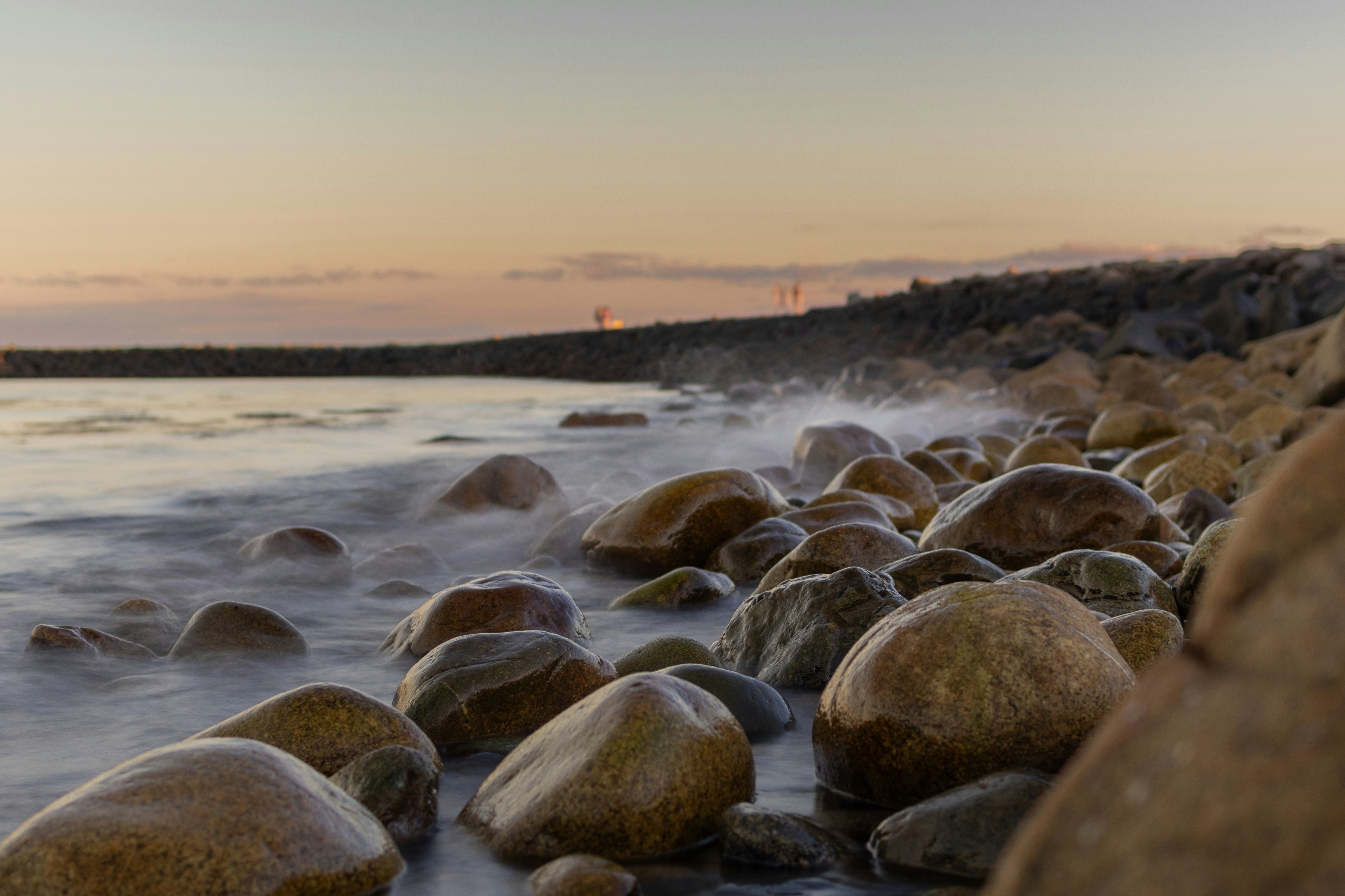 Pebble Reach at Dusk: Tide-Washed Stones Along the Jetty