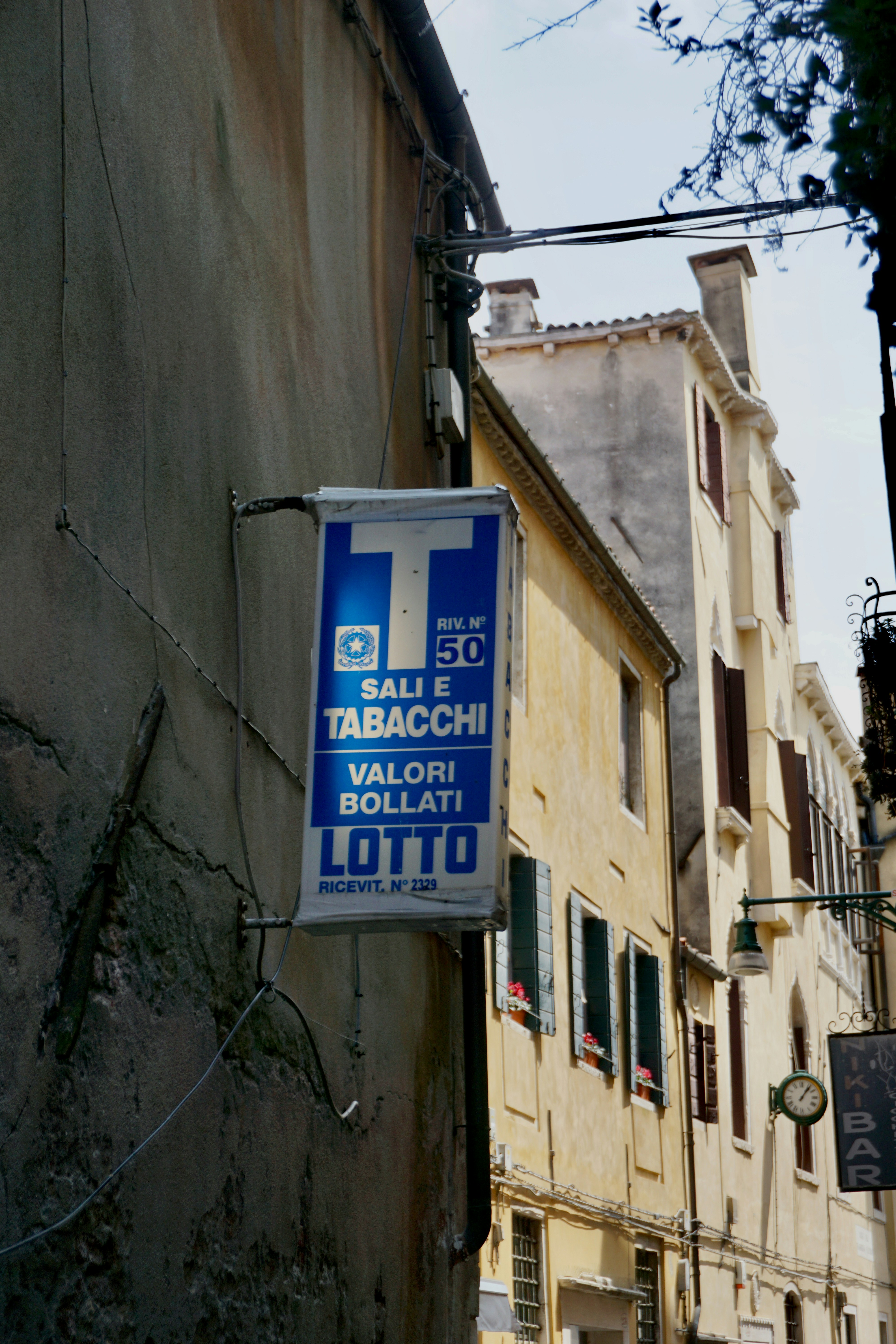 Blue Signage on a Narrow European Street