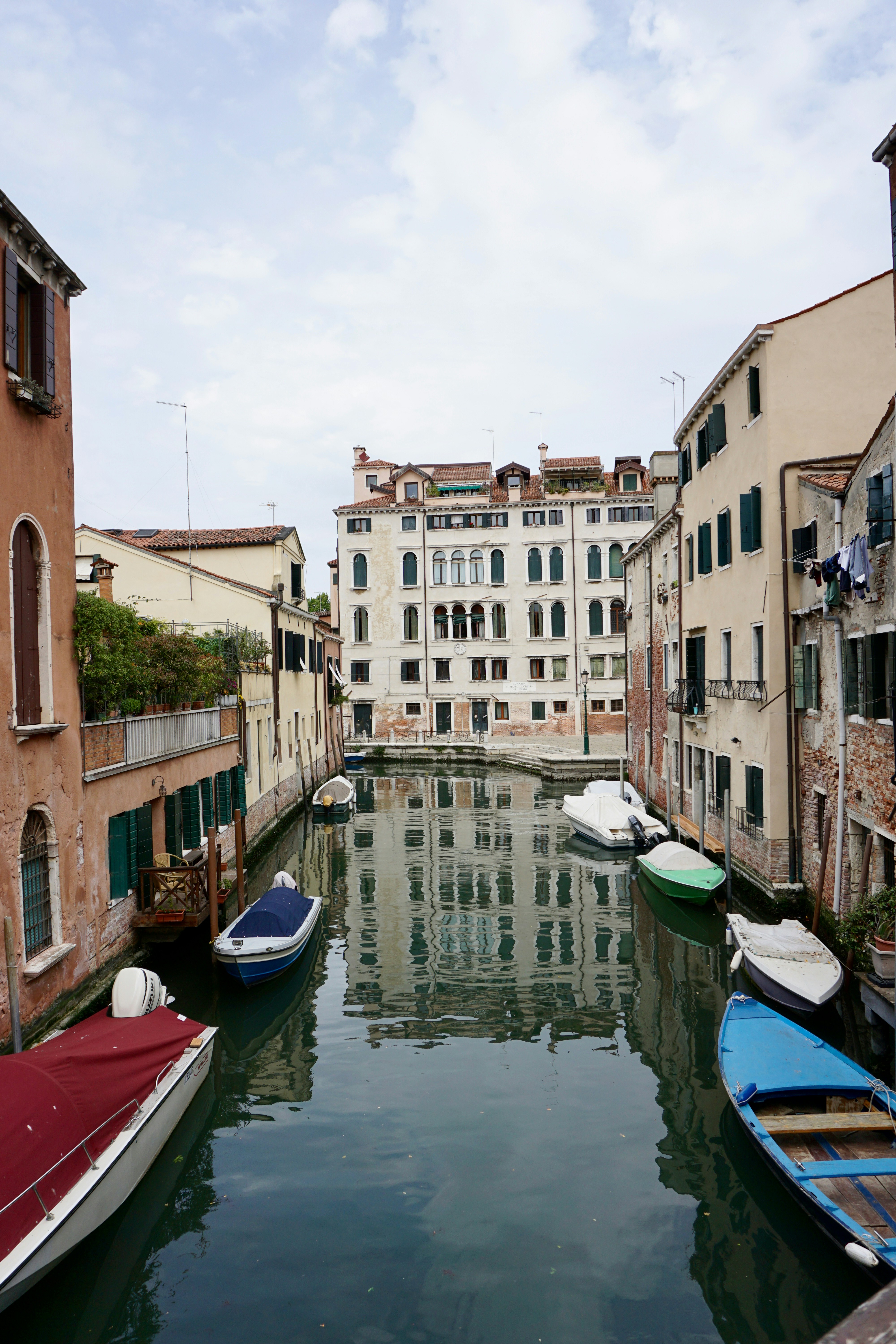 Venetian Canal Portrait: Boats Rest Along a Quiet Waterway