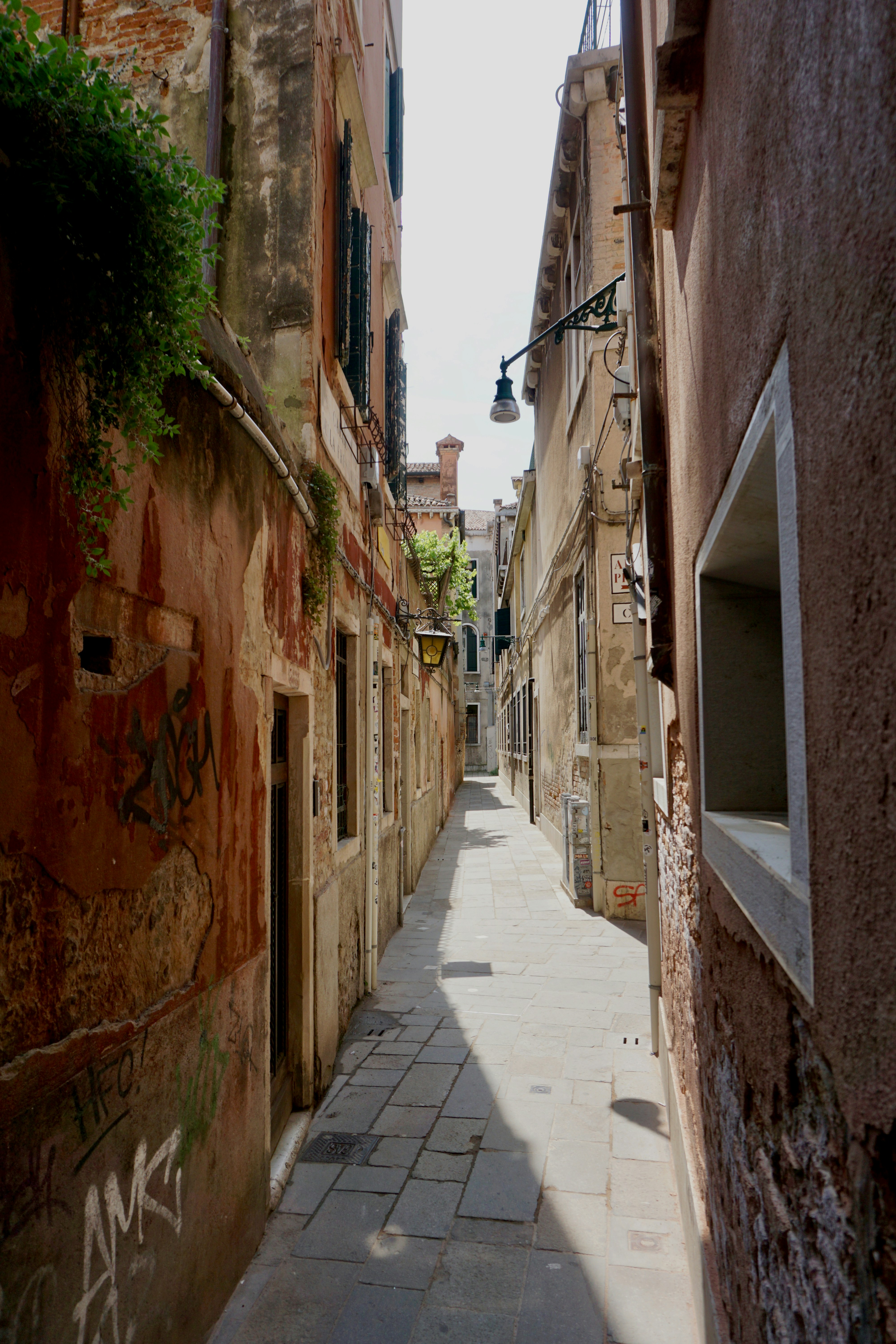 Sunlit Passage Through a Historic European Alley
