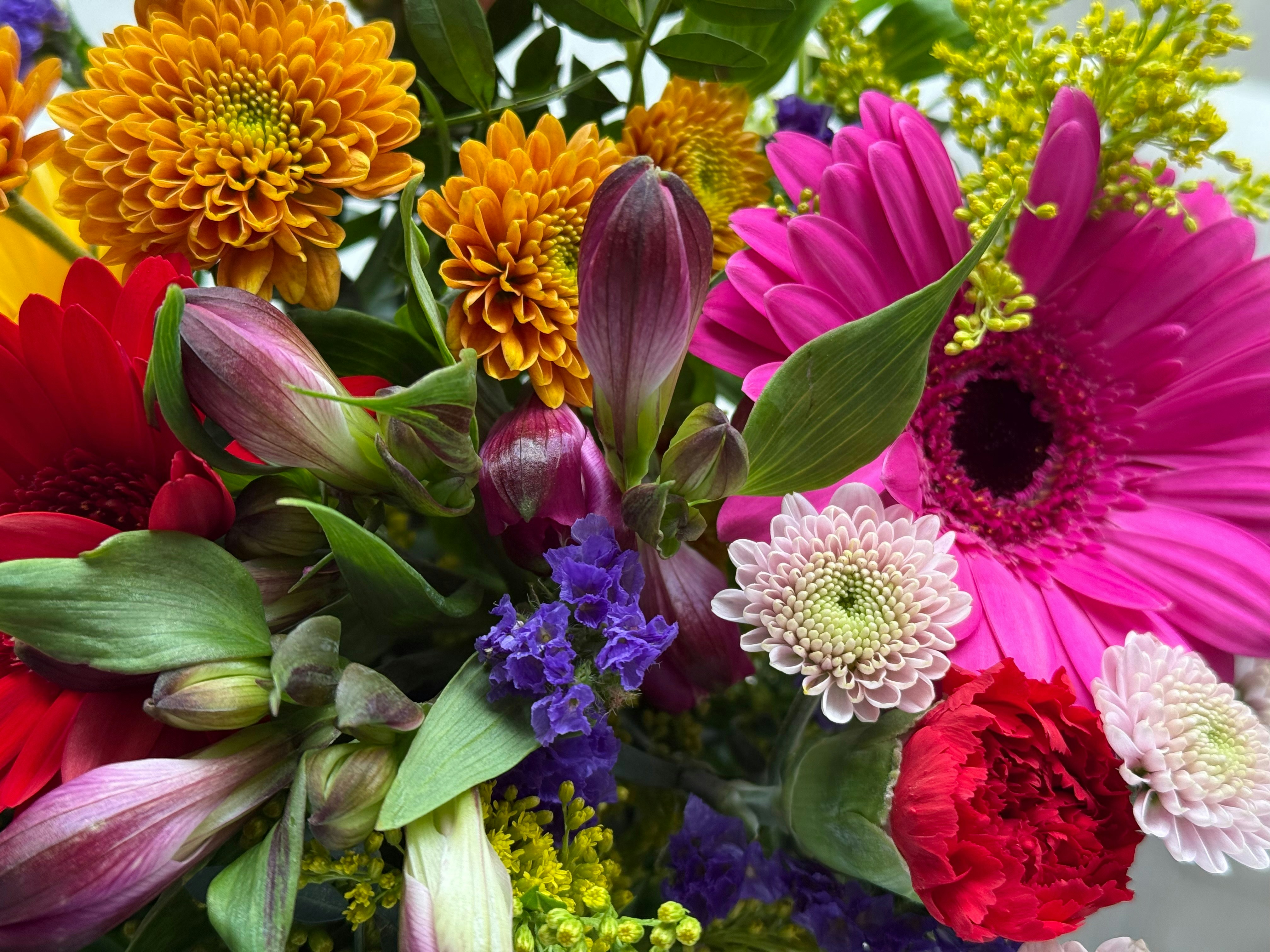 Vivid Bouquet Chorus: Orange Marigolds and Pink Gerberas Amid Emerald Greens