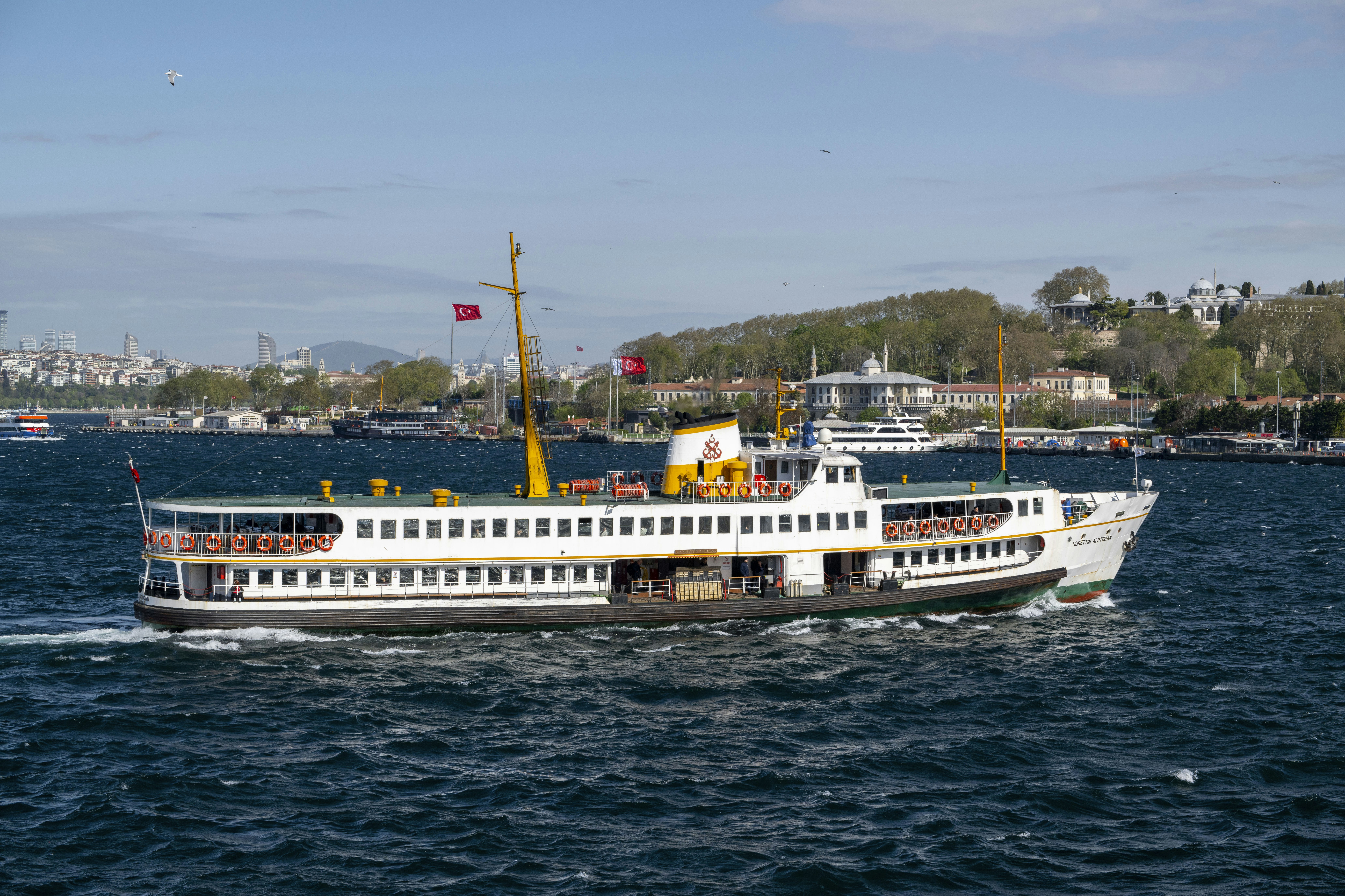 Historic ferry gliding across sapphire harbor