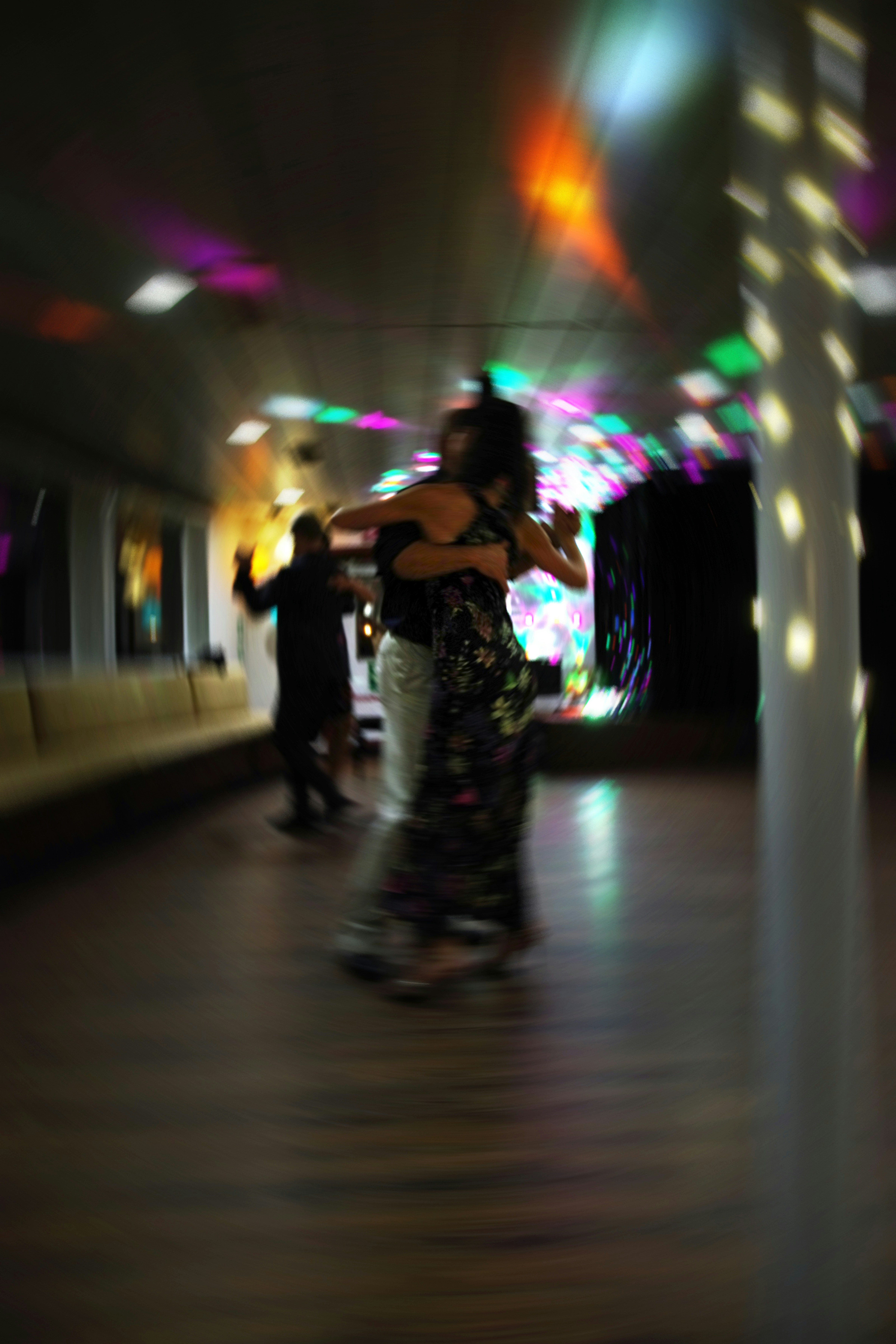 Dancing in Colored Light: A Blurred Ballroom Moment