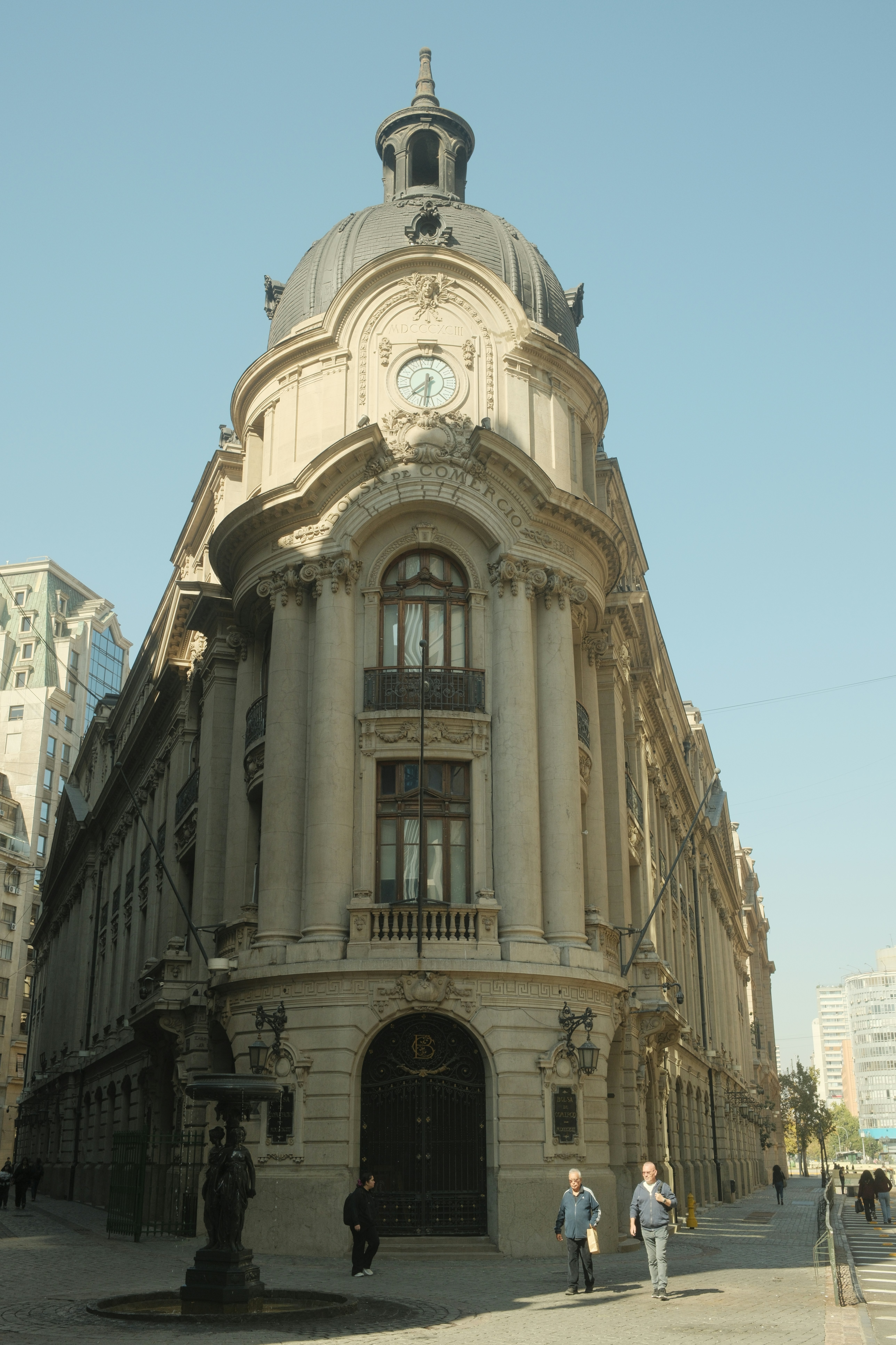 Façade of Grandeur: A Neoclassical Corner on a Sunlit City Street