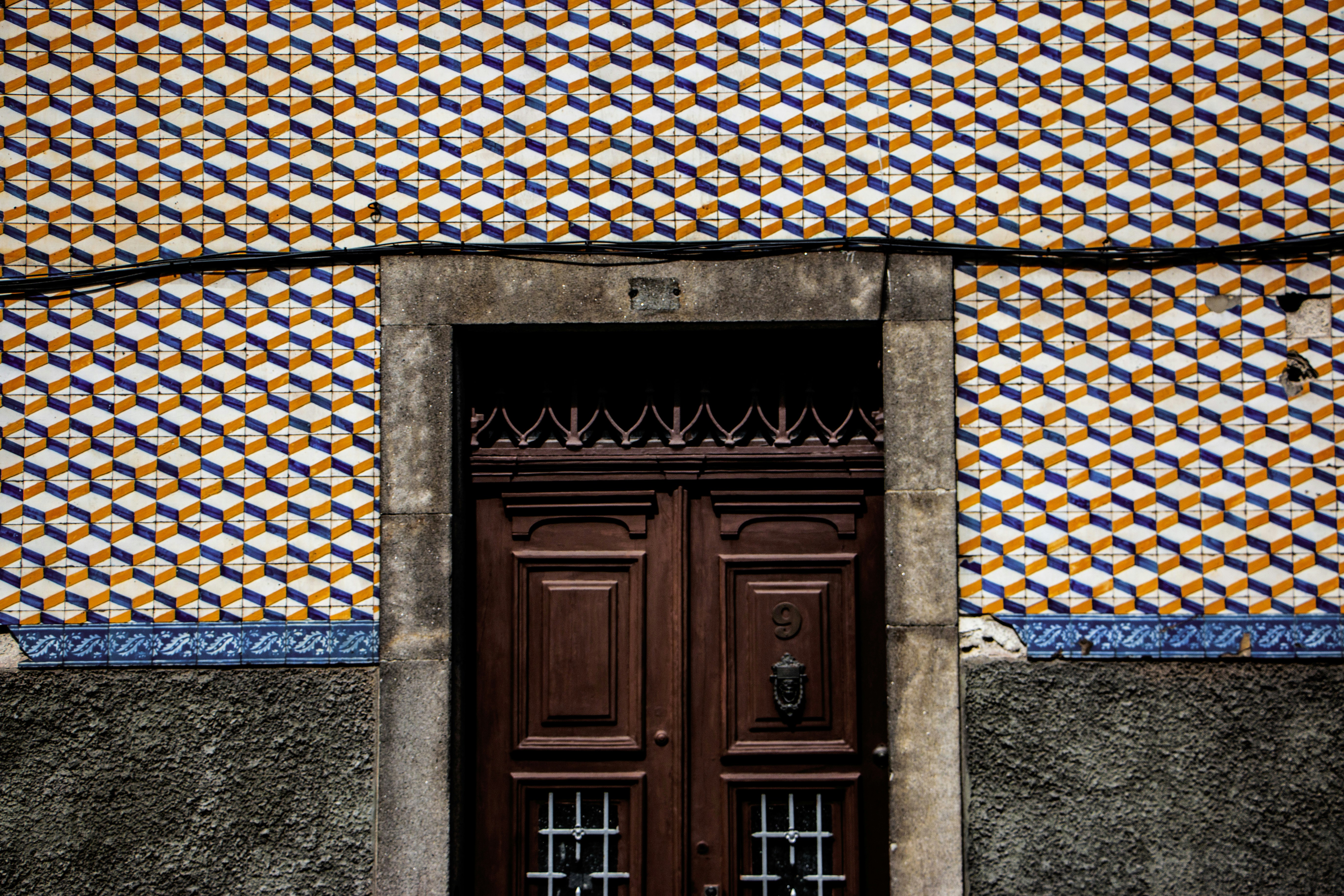 Weathered Door Framed by Mosaic Tiles