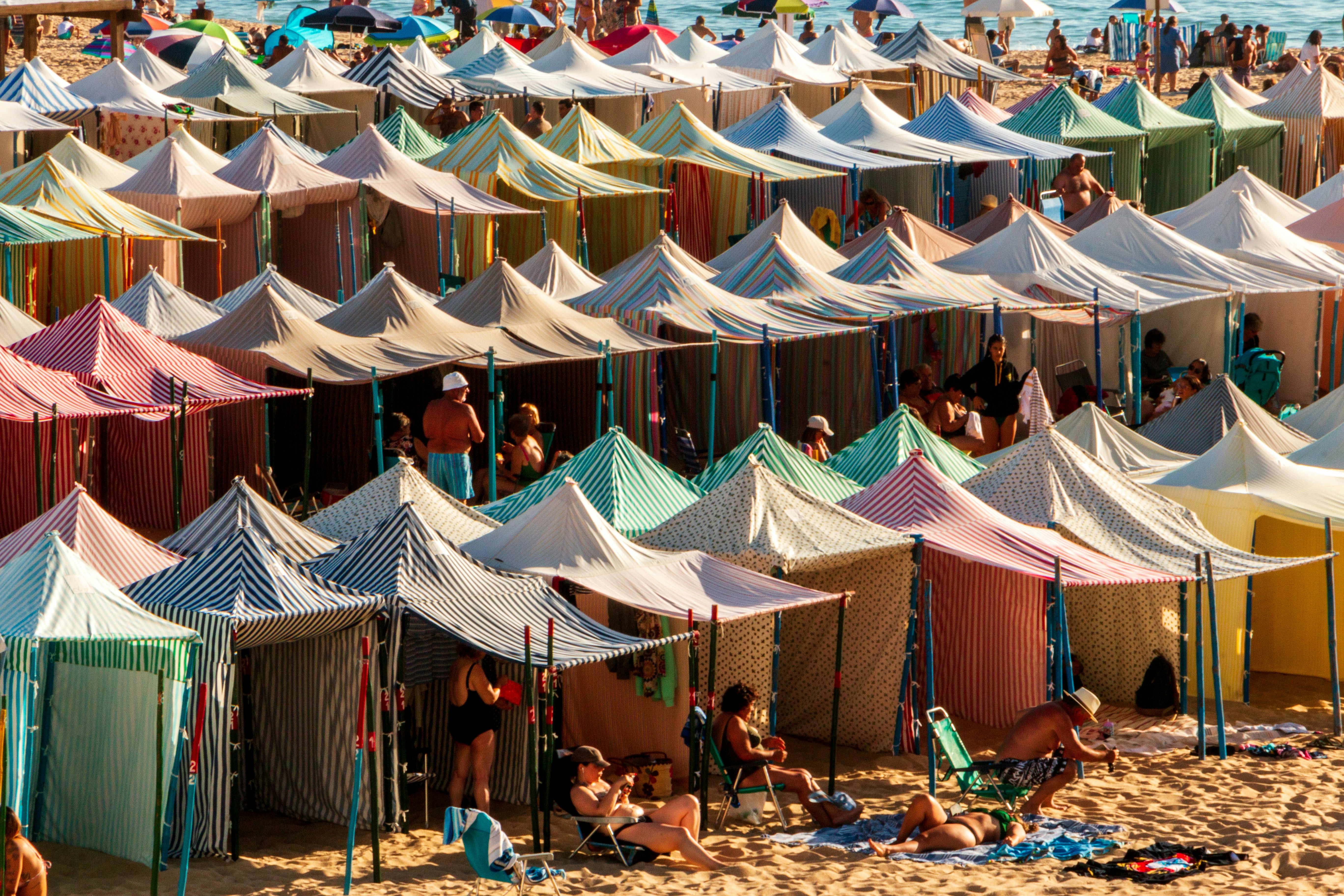 Symphony of Striped Canopies: A Sunlit Beach Mosaic