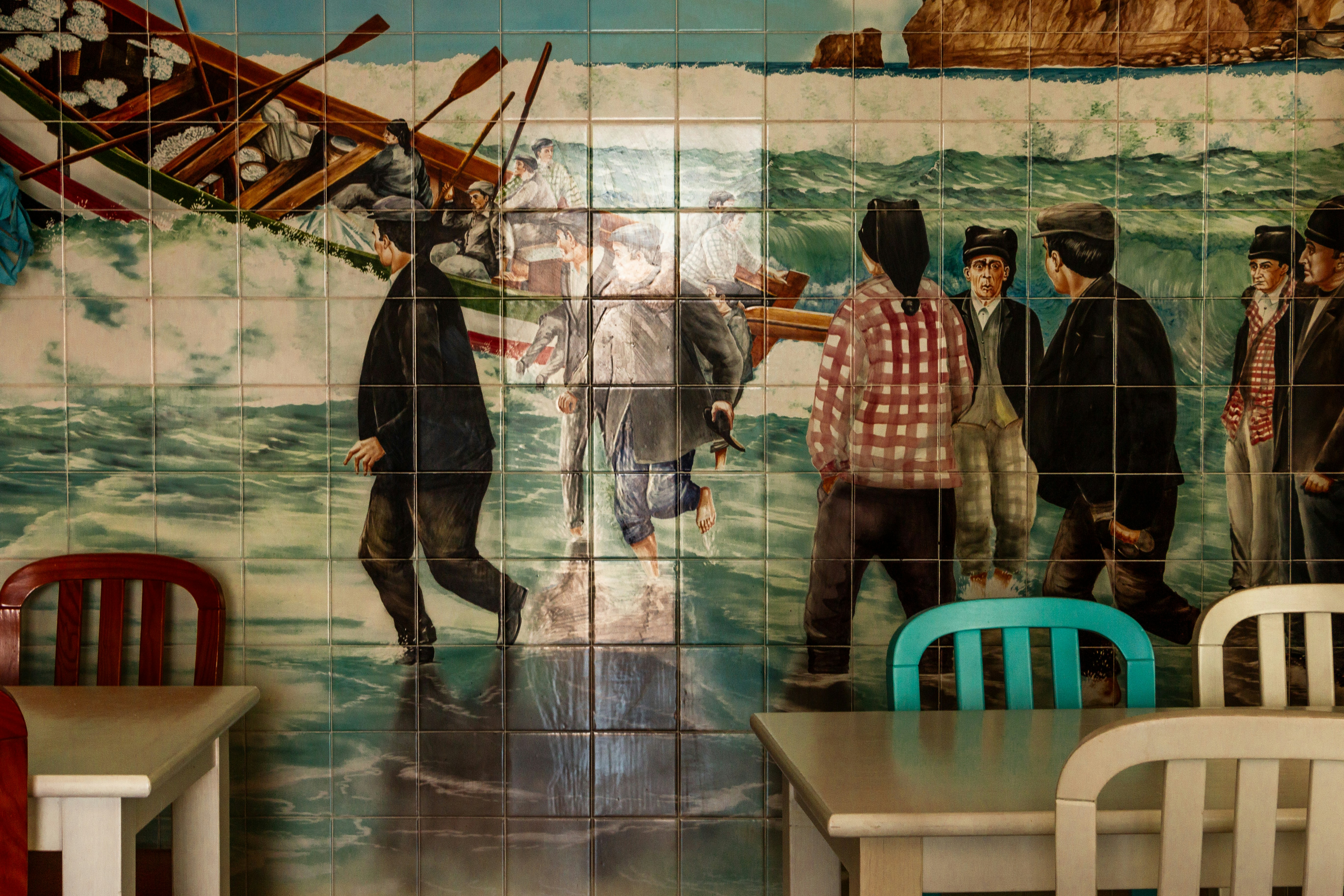 A seaside mural at a sunlit cafe