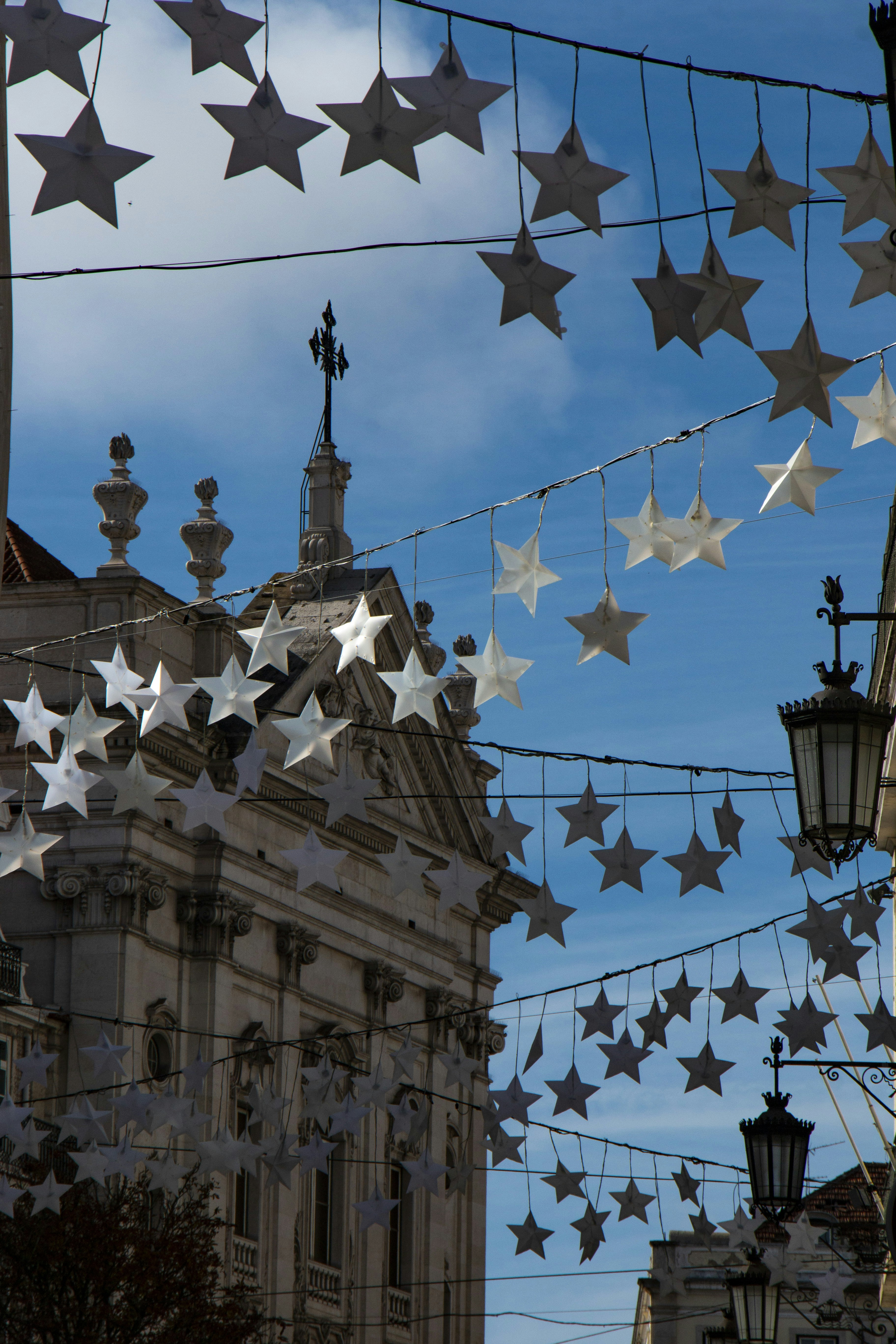 Starry Street: Festooned Sky Over a Historic Facade