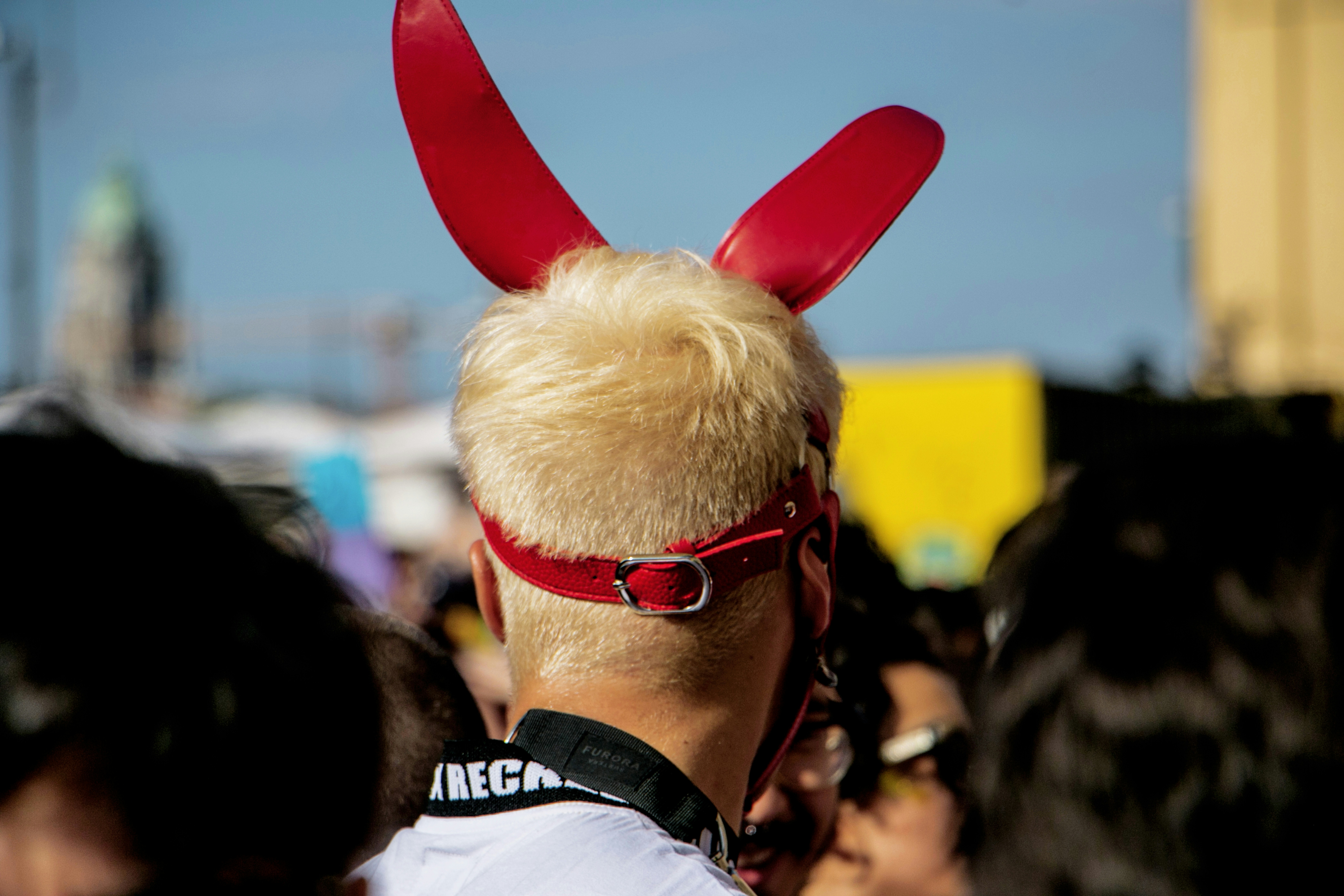 Red Bunny Ears Over a Crowd: A Blonde Head in a Sea of Adults