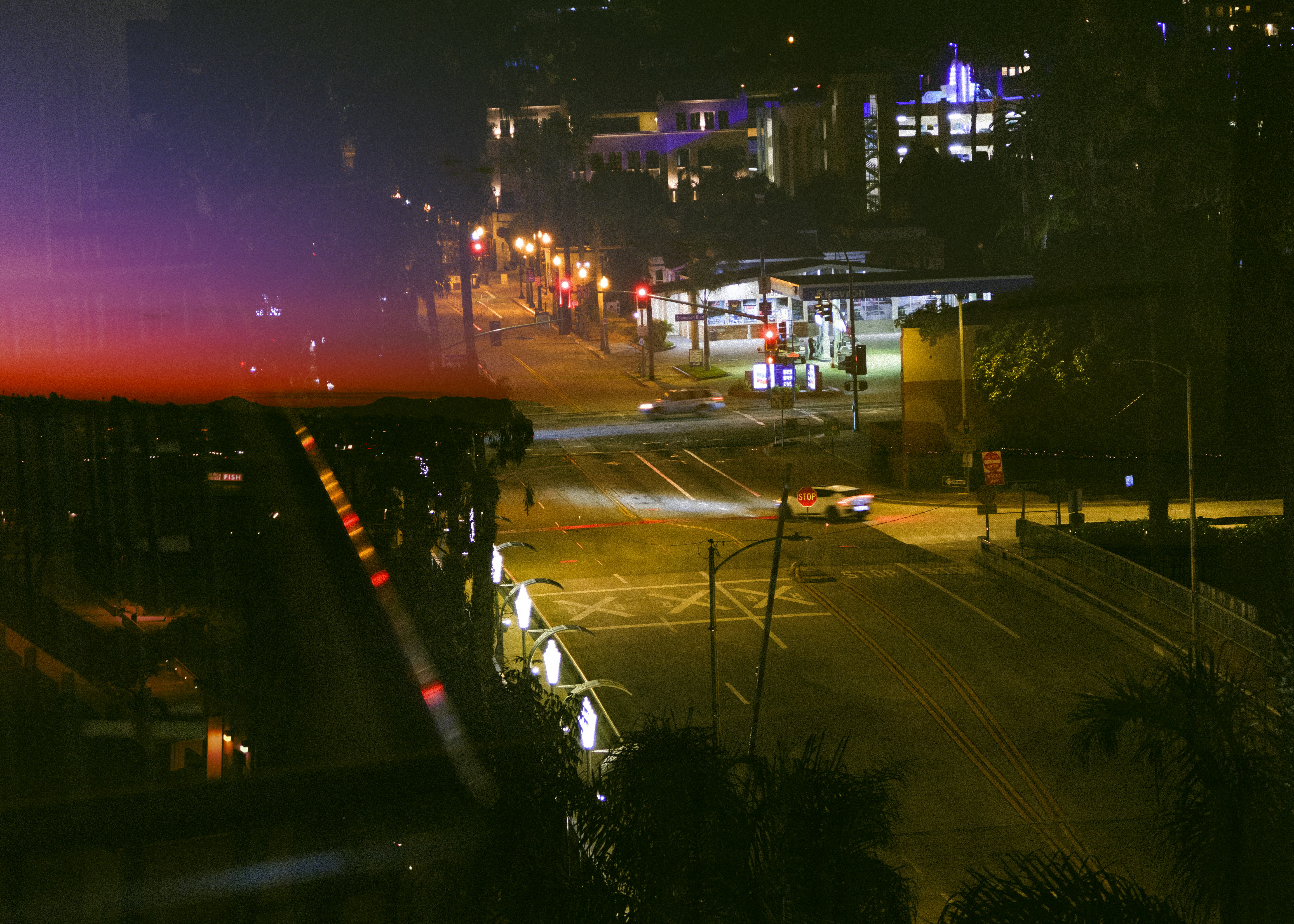 Night Streetlights and Neon Reflections Over a Quiet Downtown