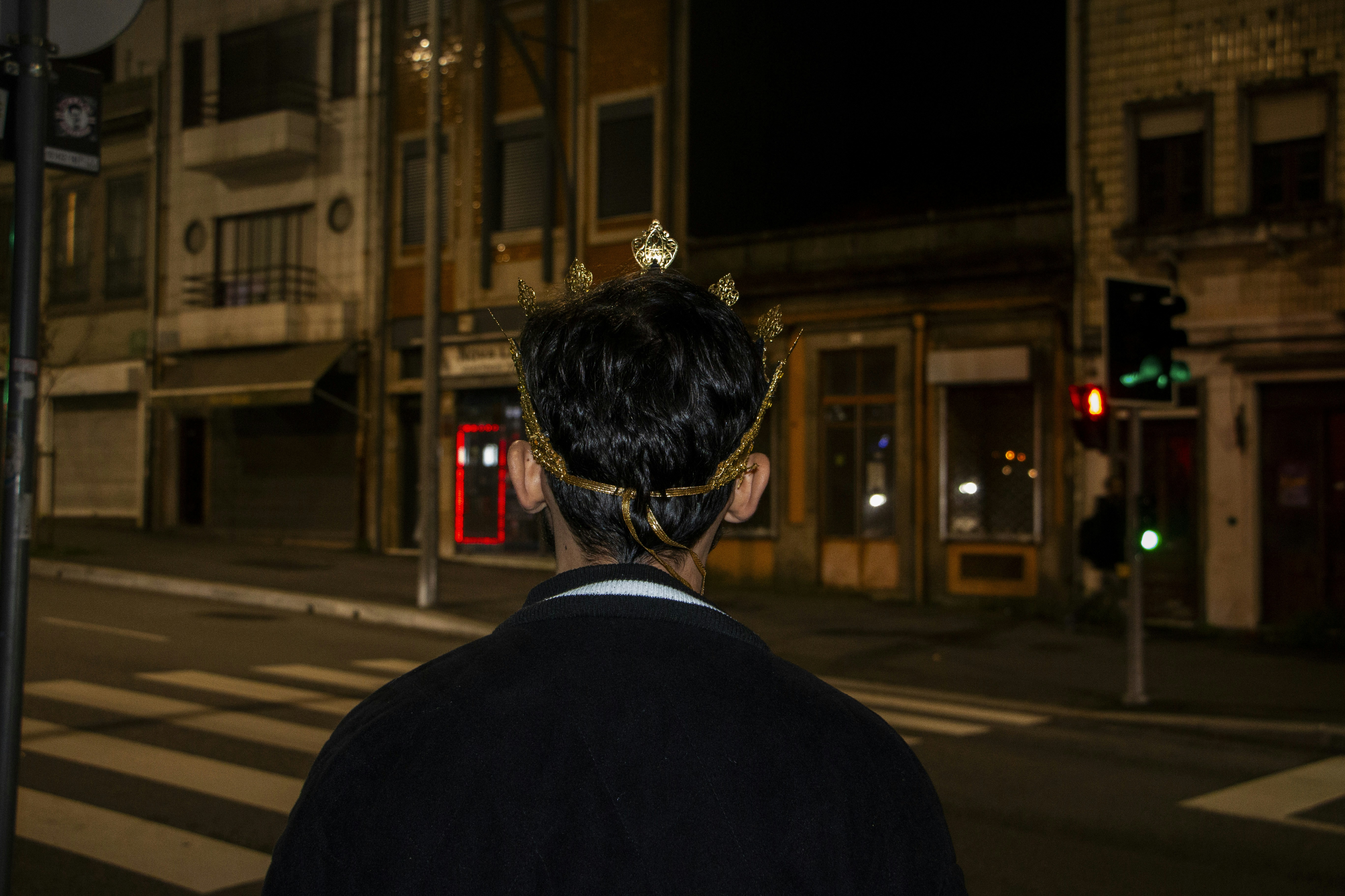 Crowned in the Night: Back of a Figure at a Neon Street