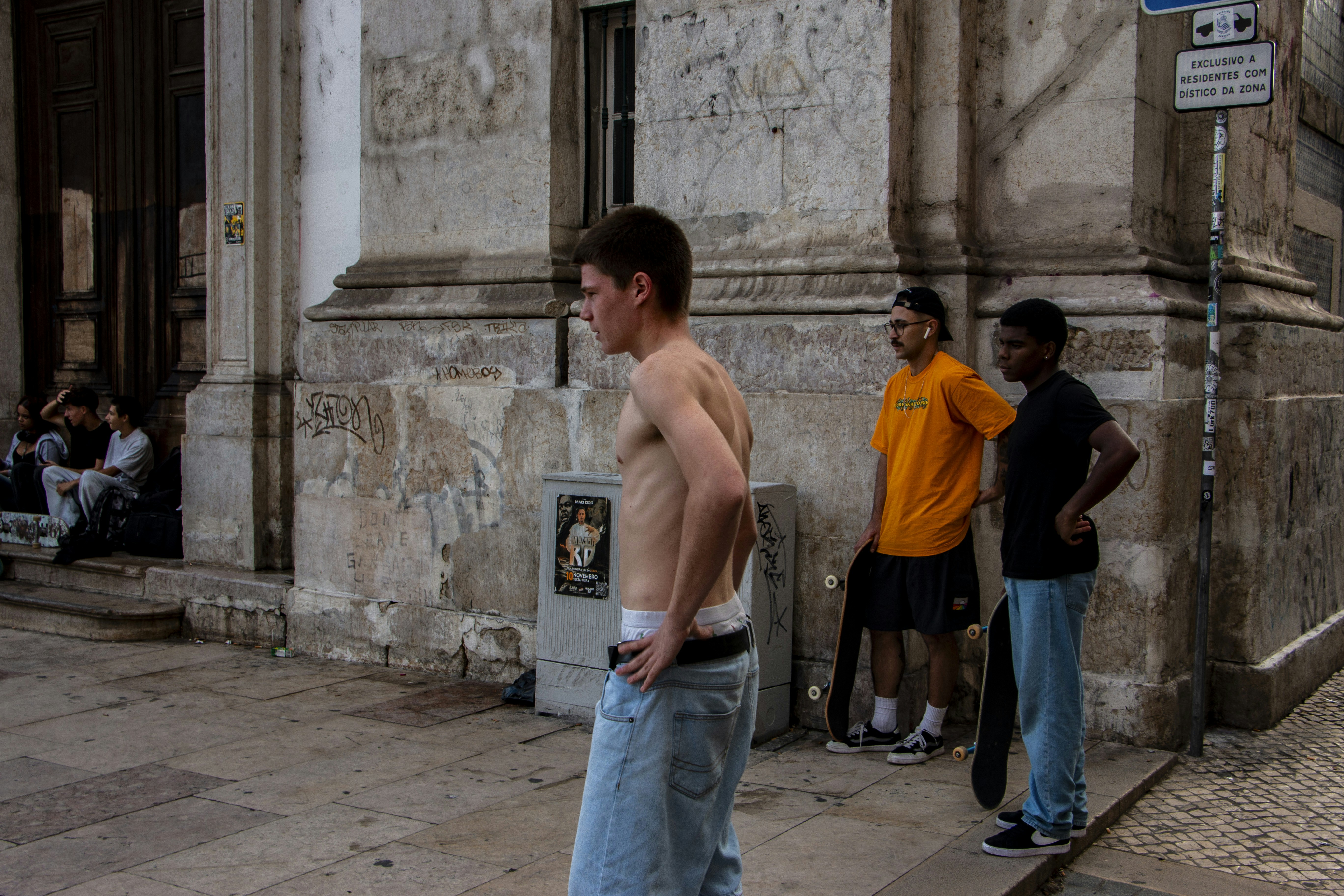 Street Pride: A Shirtless Runner Pauses by an Old Plaza