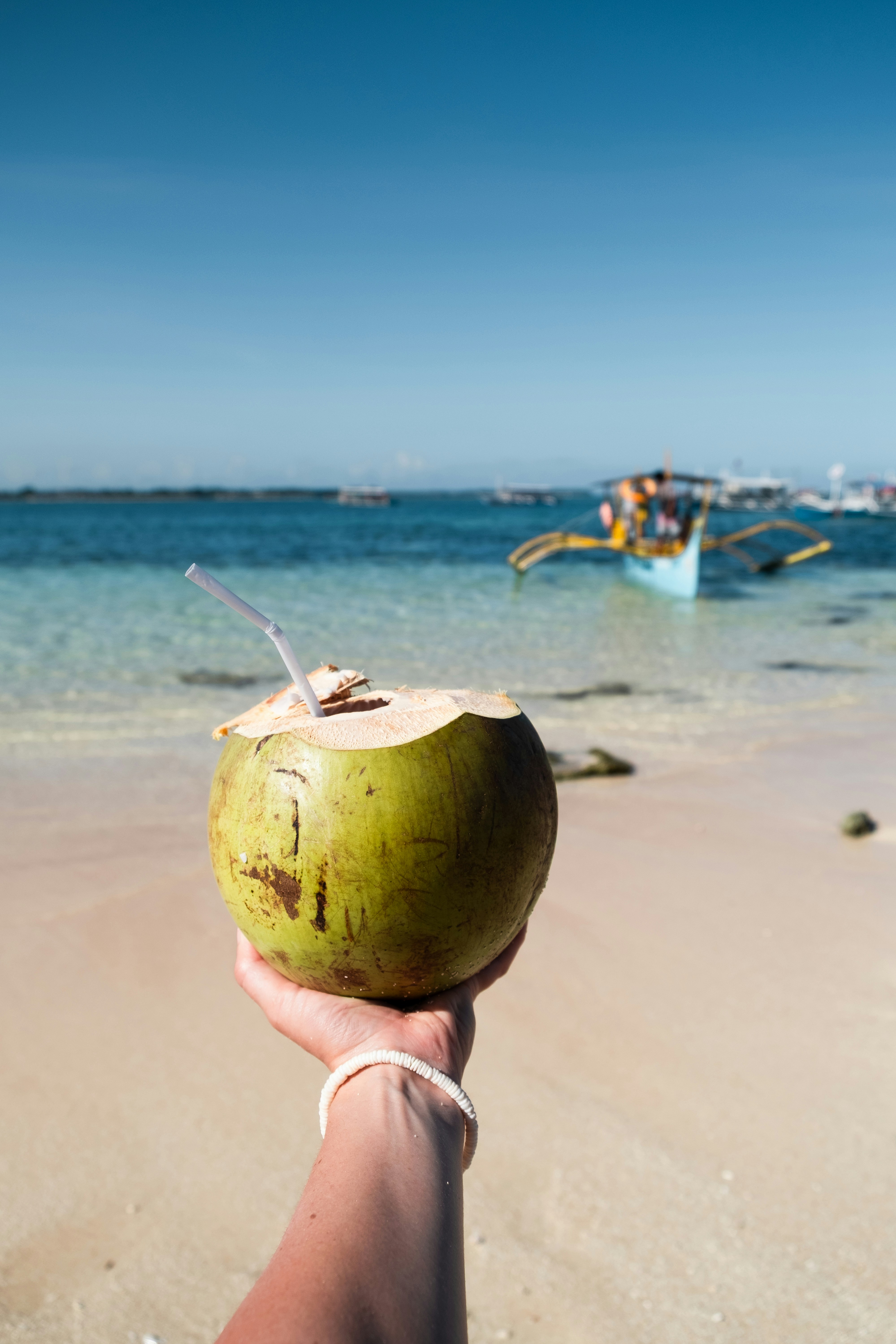 Coconut Cheers: A Sunlit Beach Moment with a Refreshing Twist