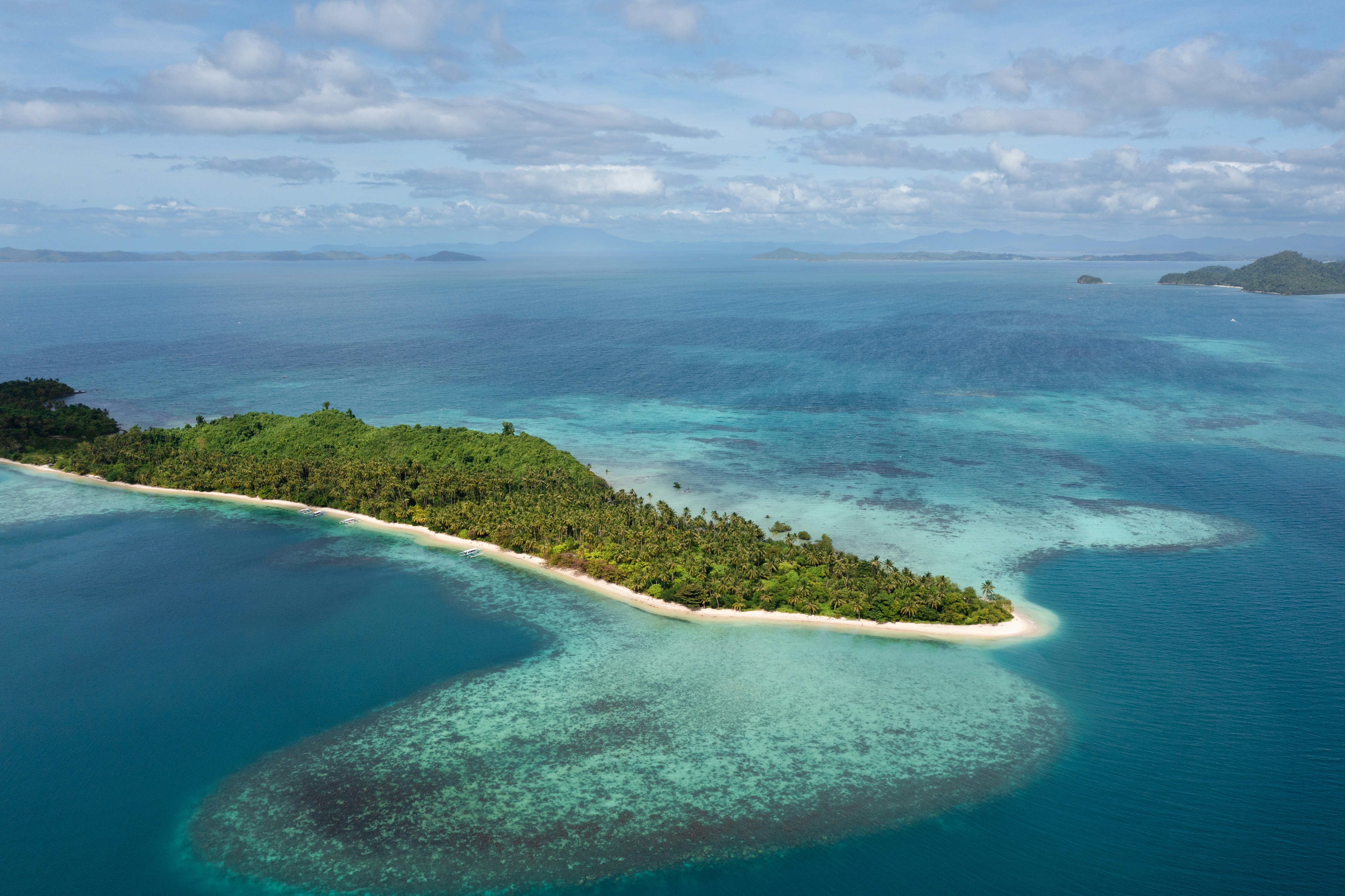 Azure Ribbon: A Crescent Island Fringed by Turquoise Reefs