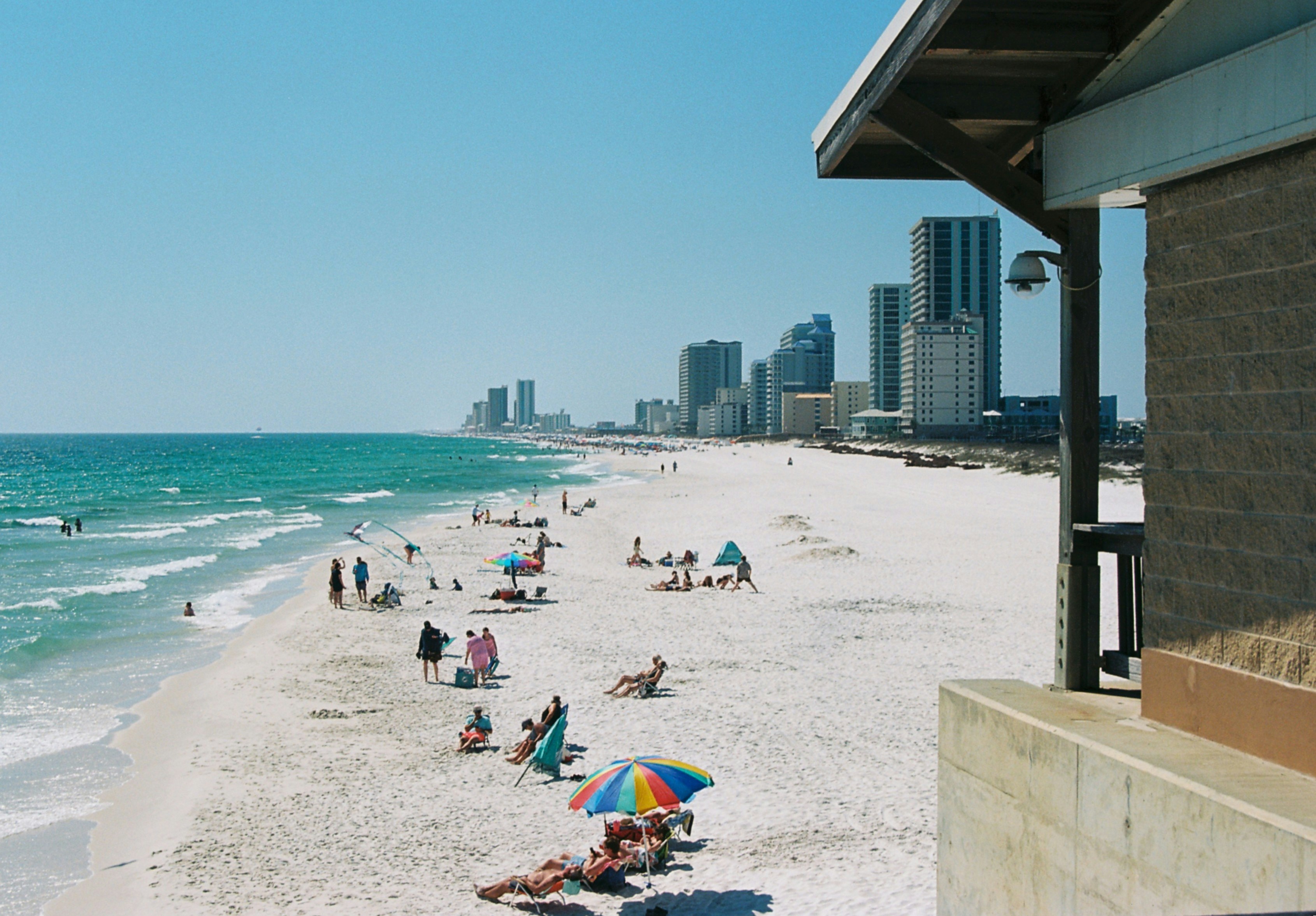 Sunlit Beachfront Rhythm: Lifeguard Hut, Sand, and Skyscrapers