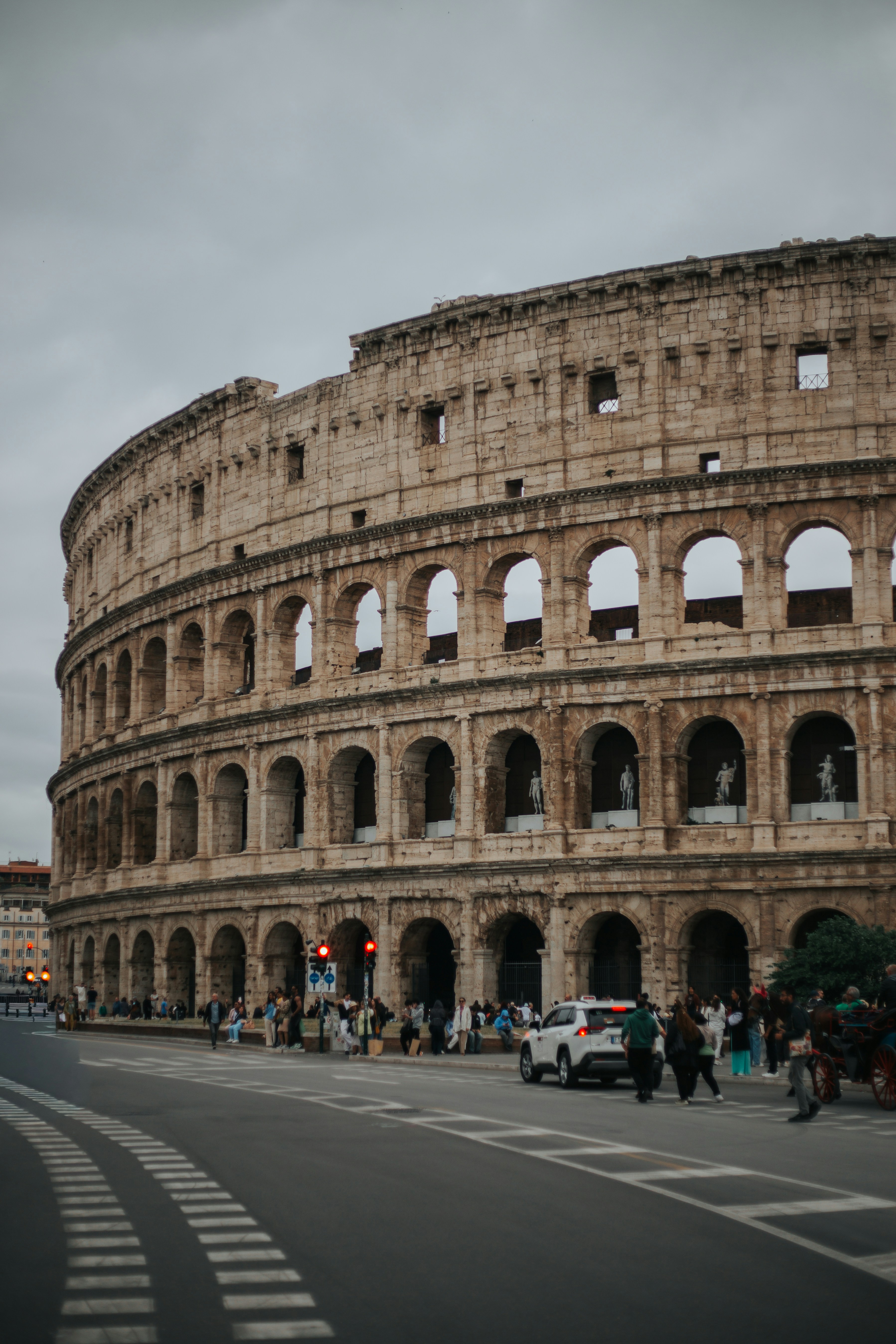 Colosseum in motion: crowds and traffic frame ancient arches
