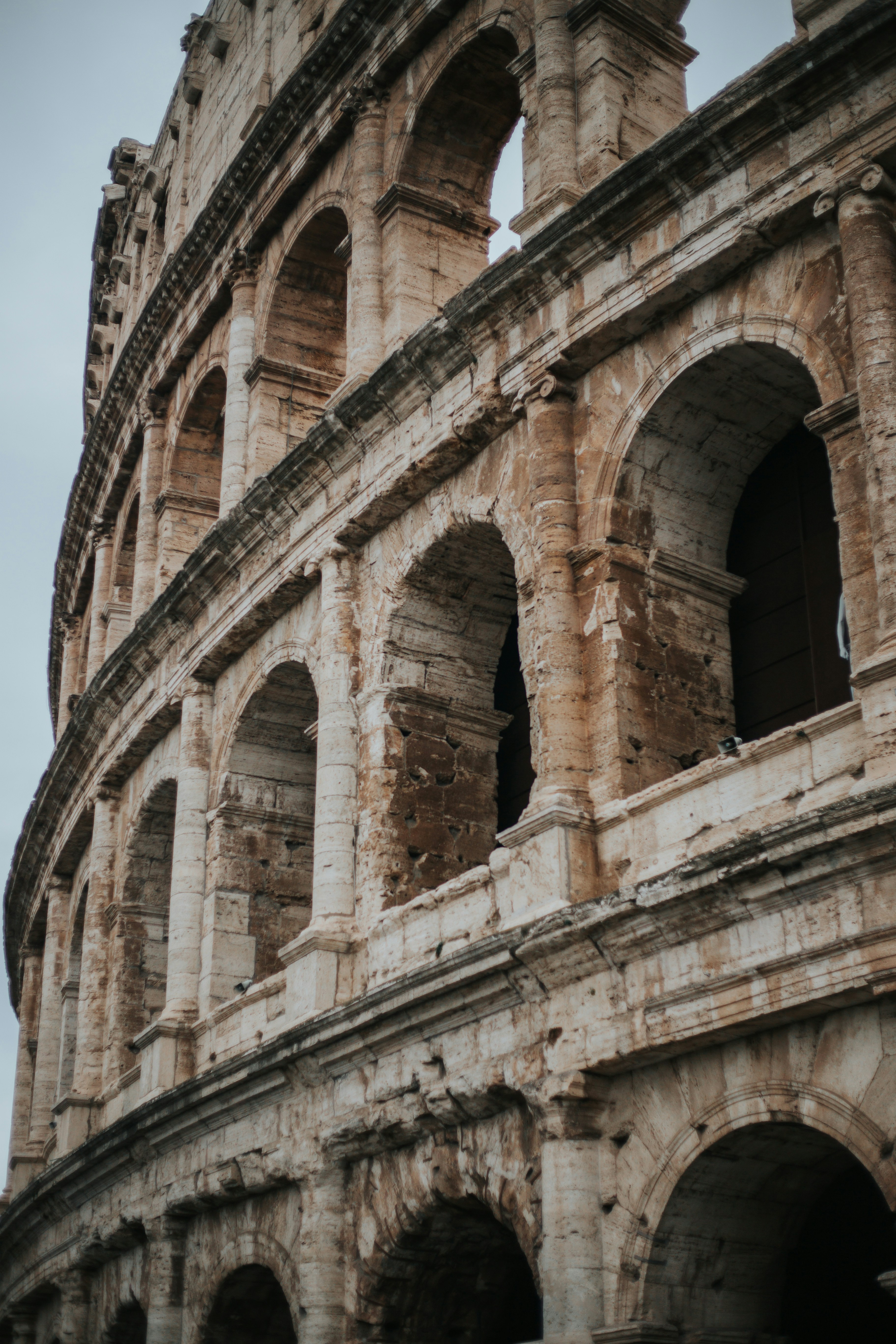 Ancient Arches: Weathered Colosseum Facade Reaching Skyward