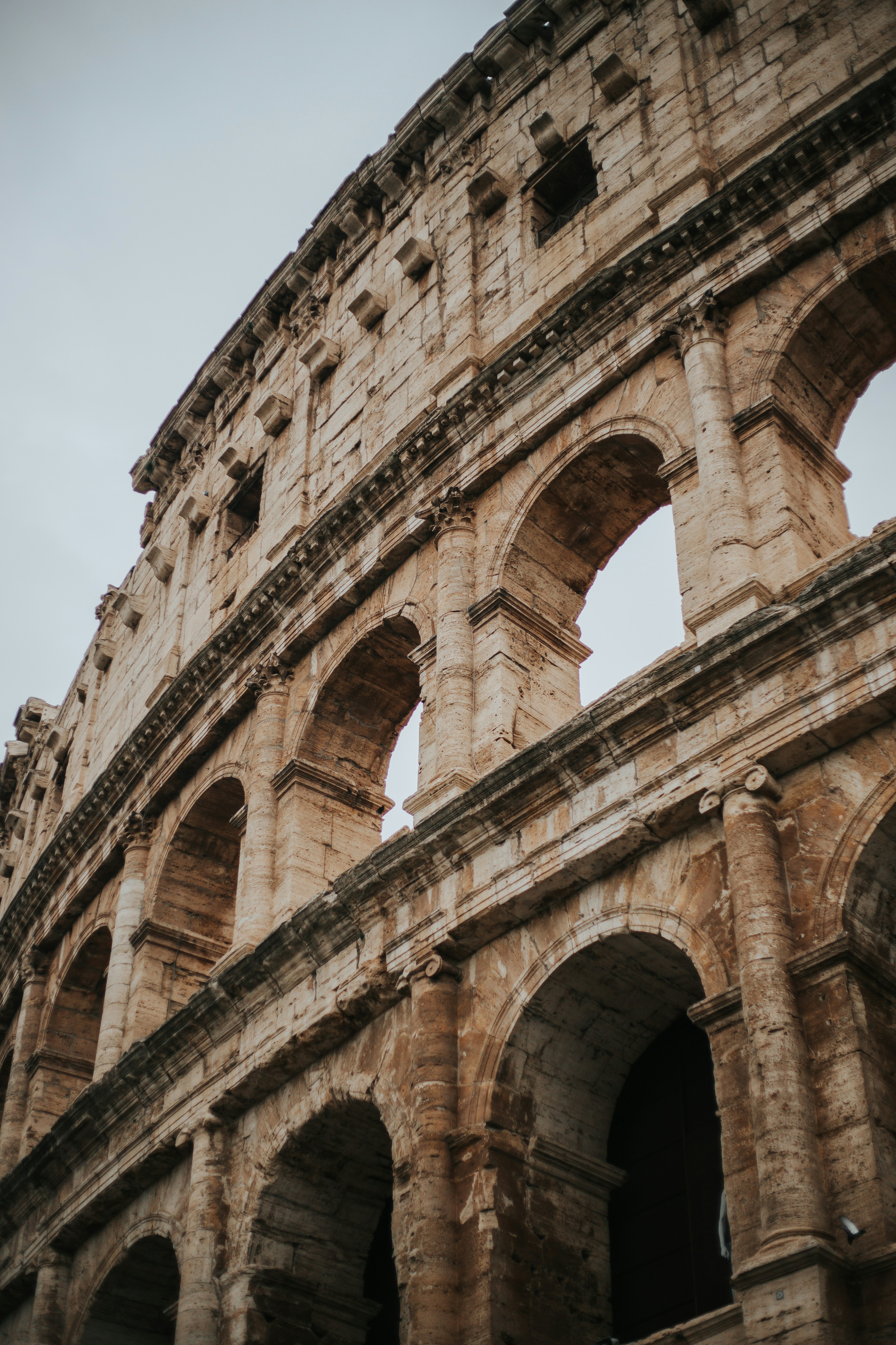 Ancient Arches: Dawn Light Graces the Colosseum Facade