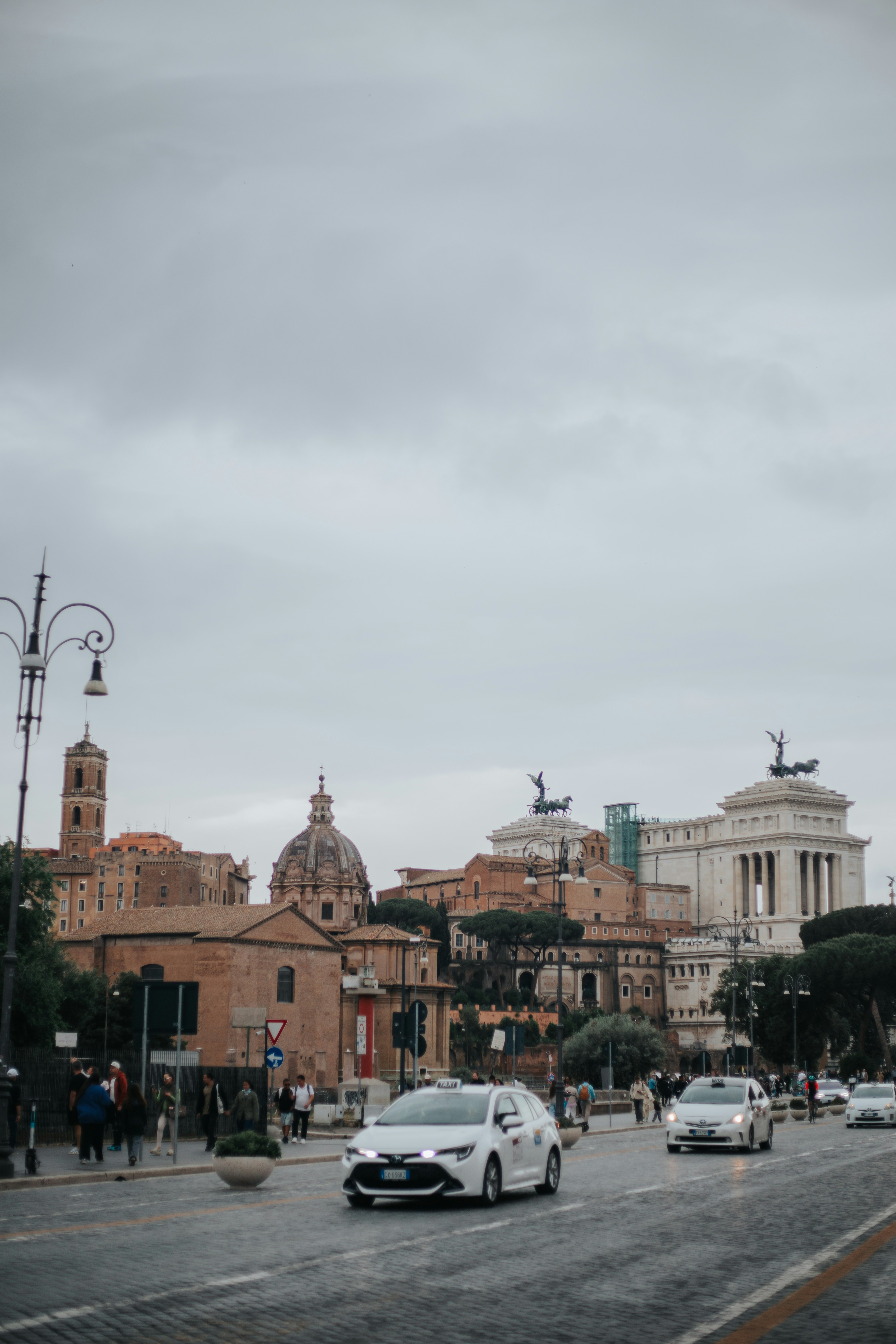 City in Motion: Cars Glide by Historic Rome