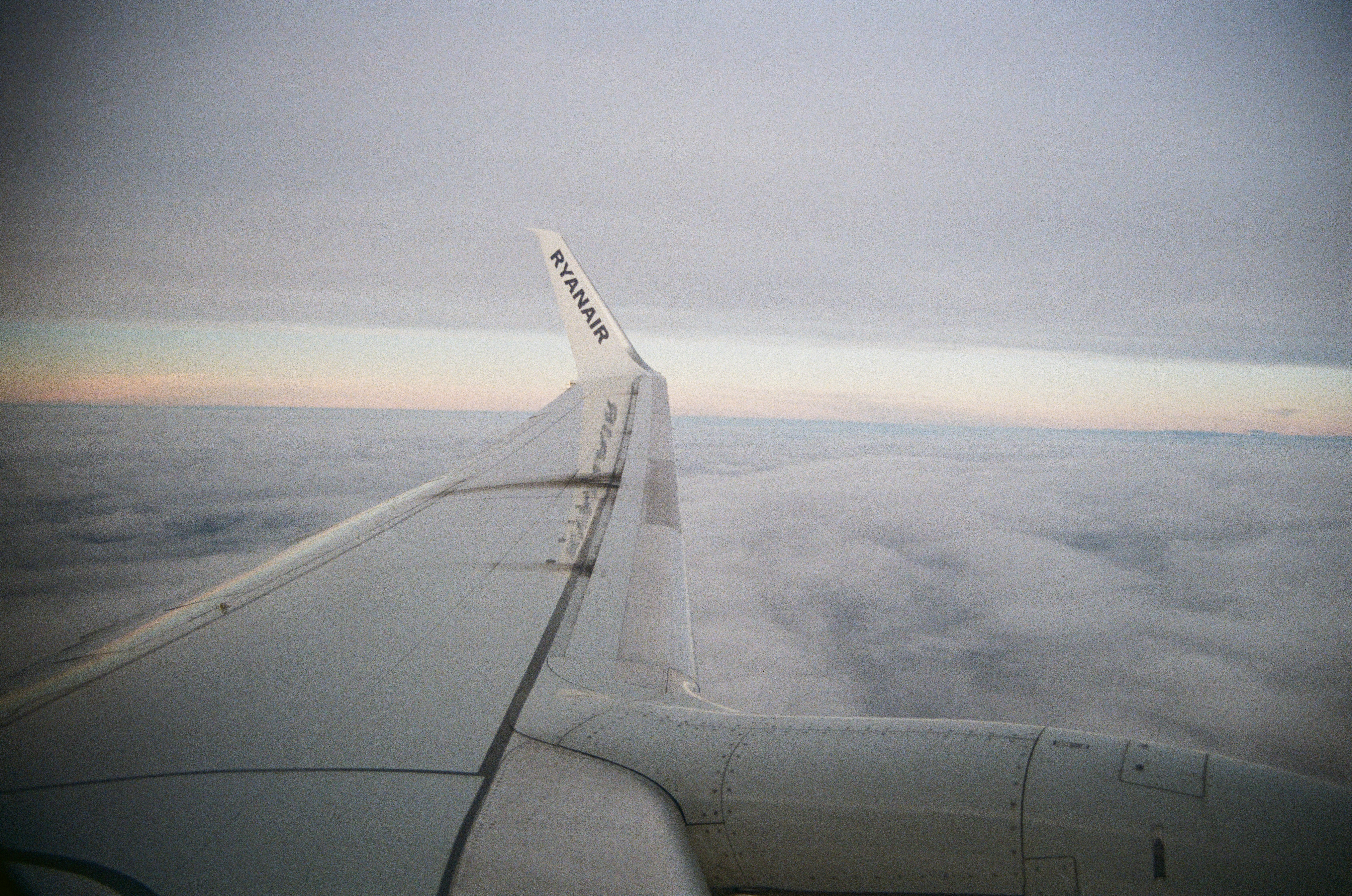 Wingtip View Over a Sea of Clouds at Sunrise