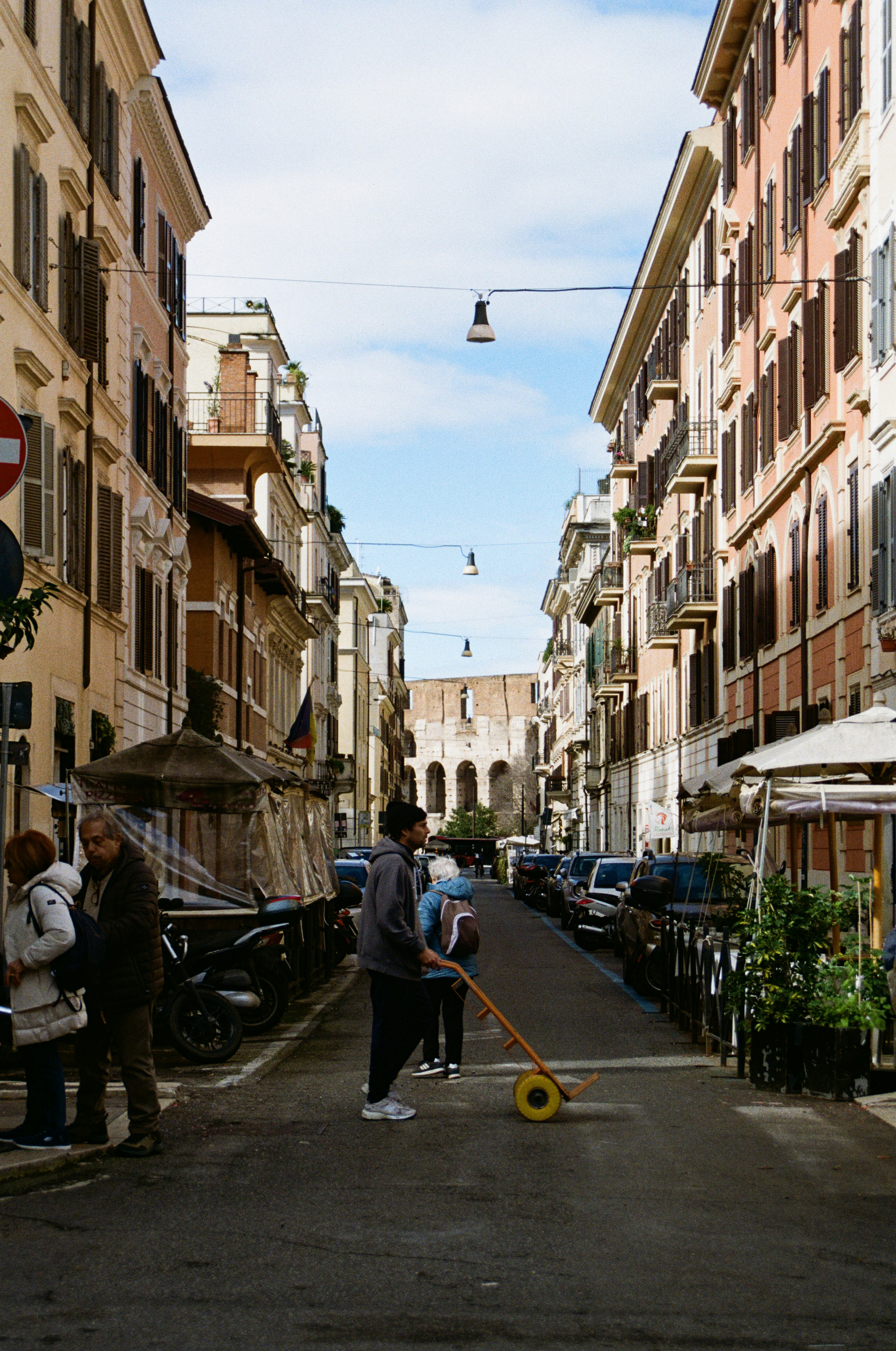 Street in Siena: A Pedestrian Moment Along a Sunlit Corridor