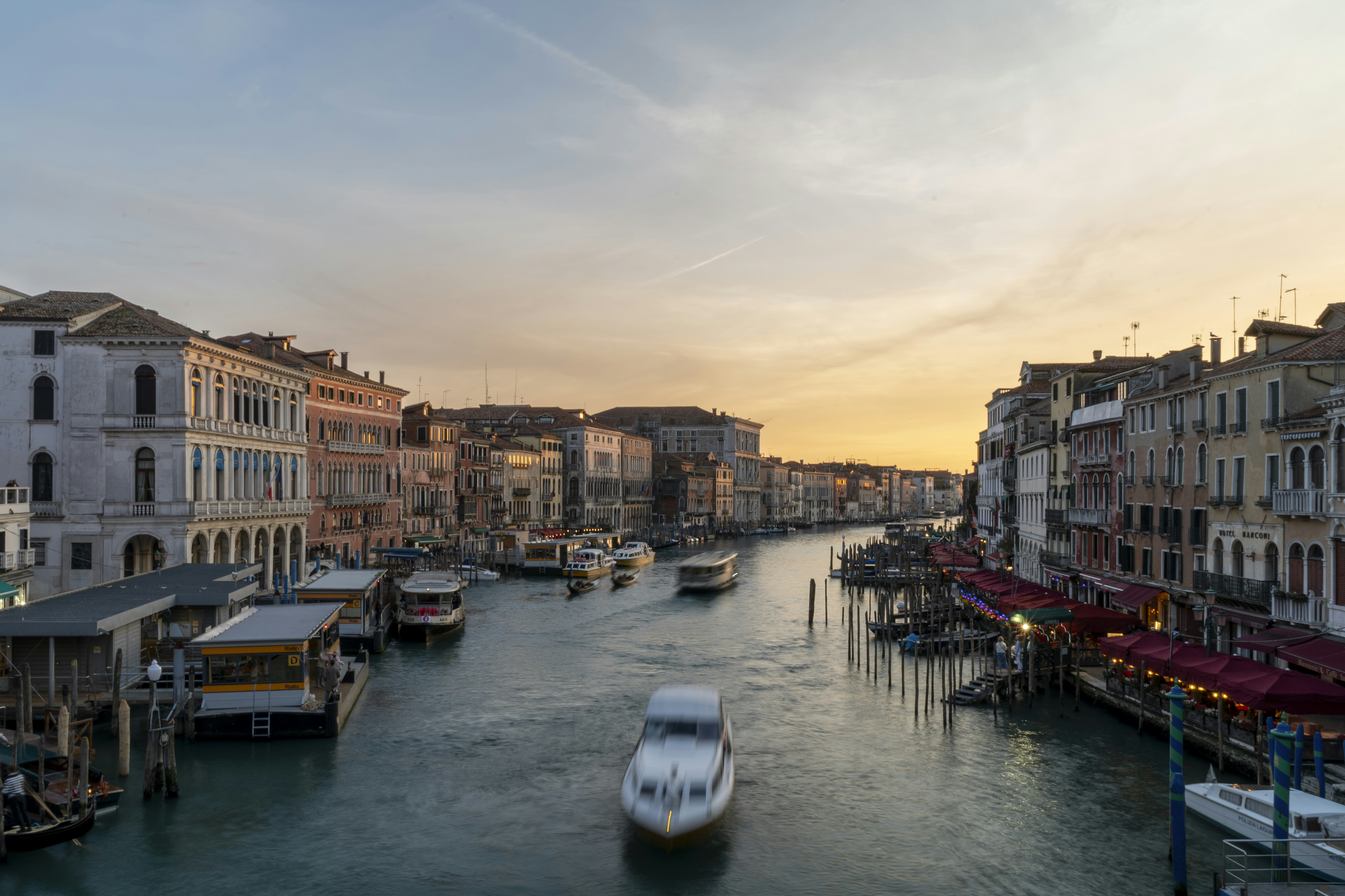 Golden Hour on the Grand Canal: Boats Drift Past Historic Facades