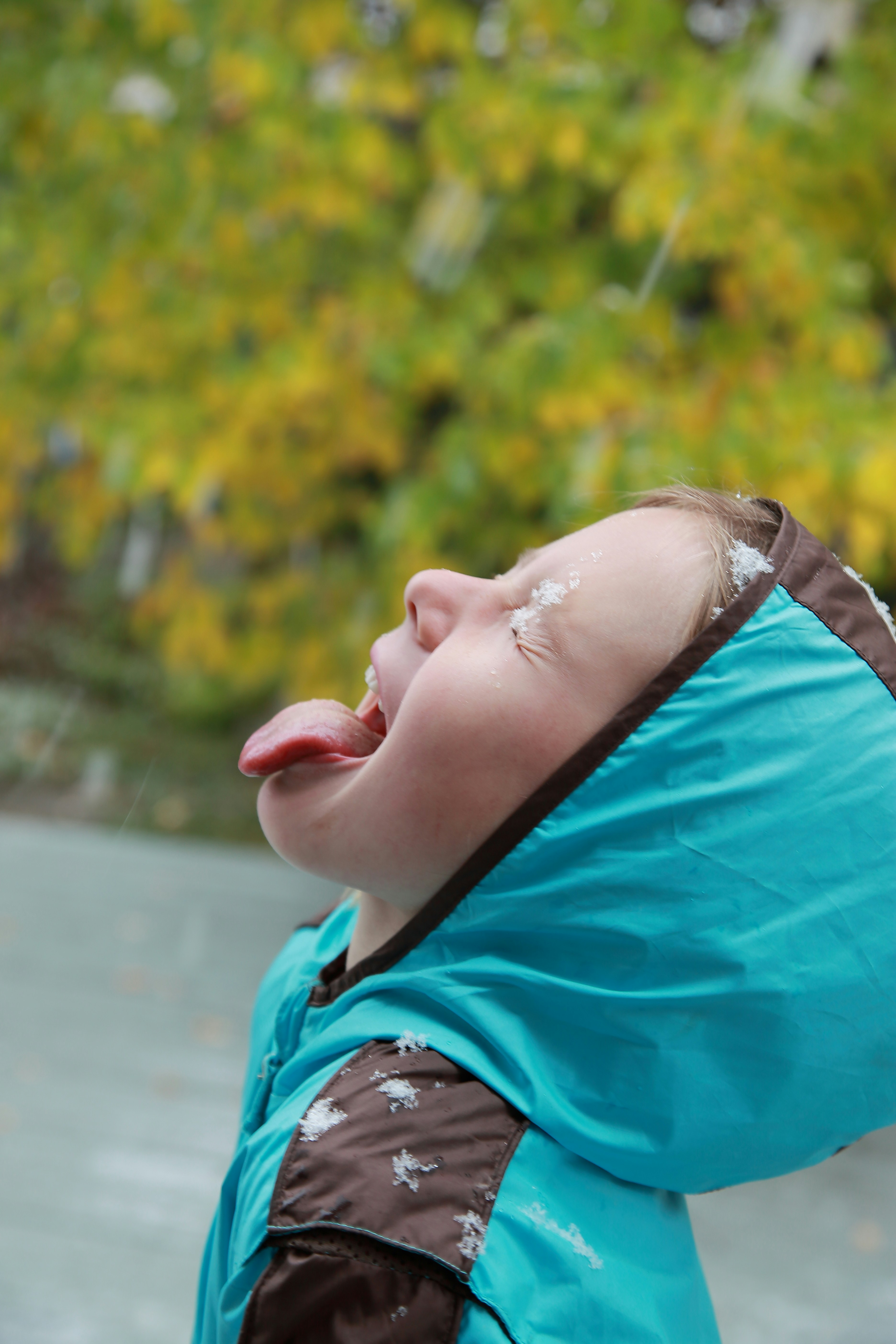 Laughter in Blue: A Child Celebrating Winter with Snow Blinks