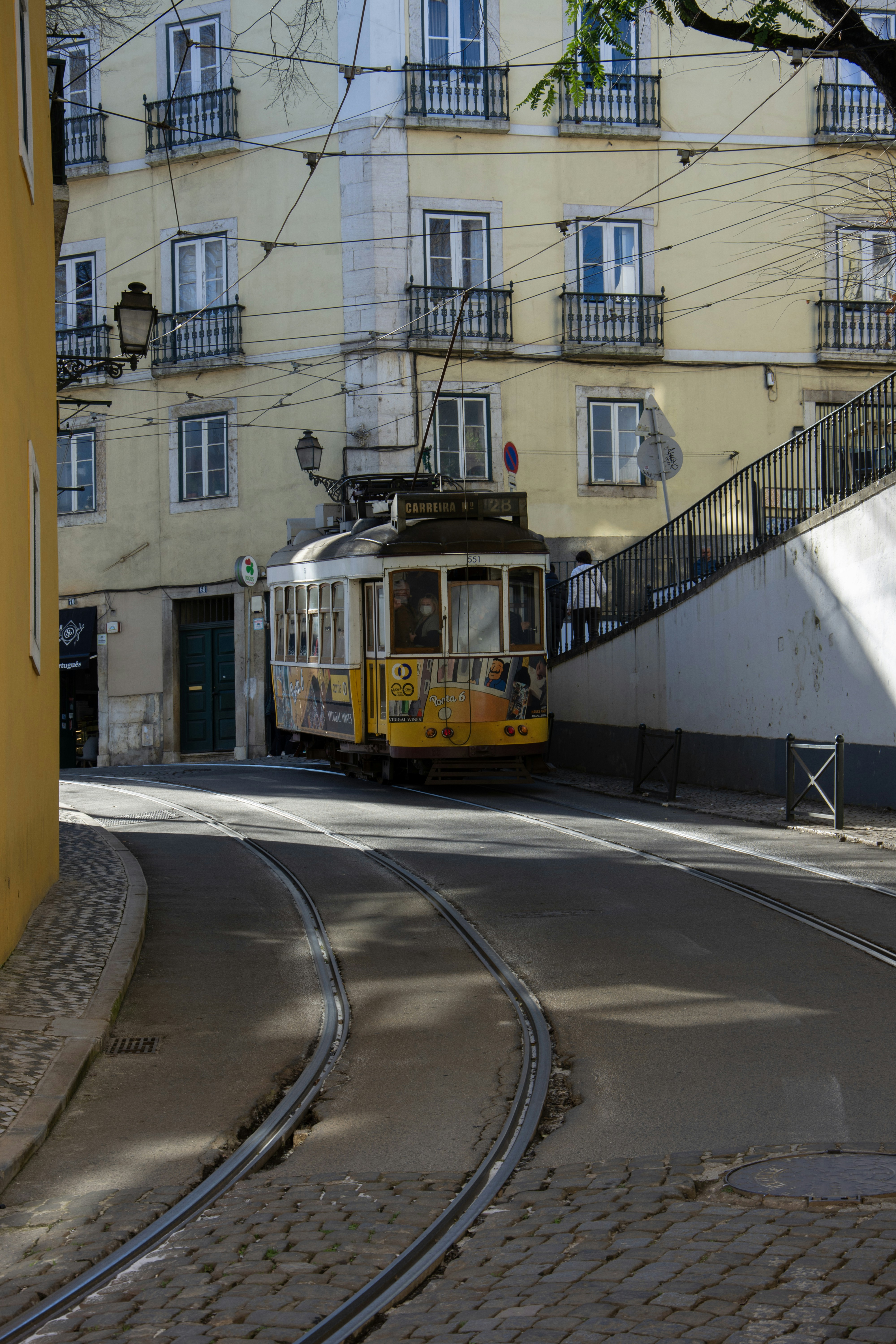 Yellow Tram Rounding a Corner beneath Sunlit European Facades