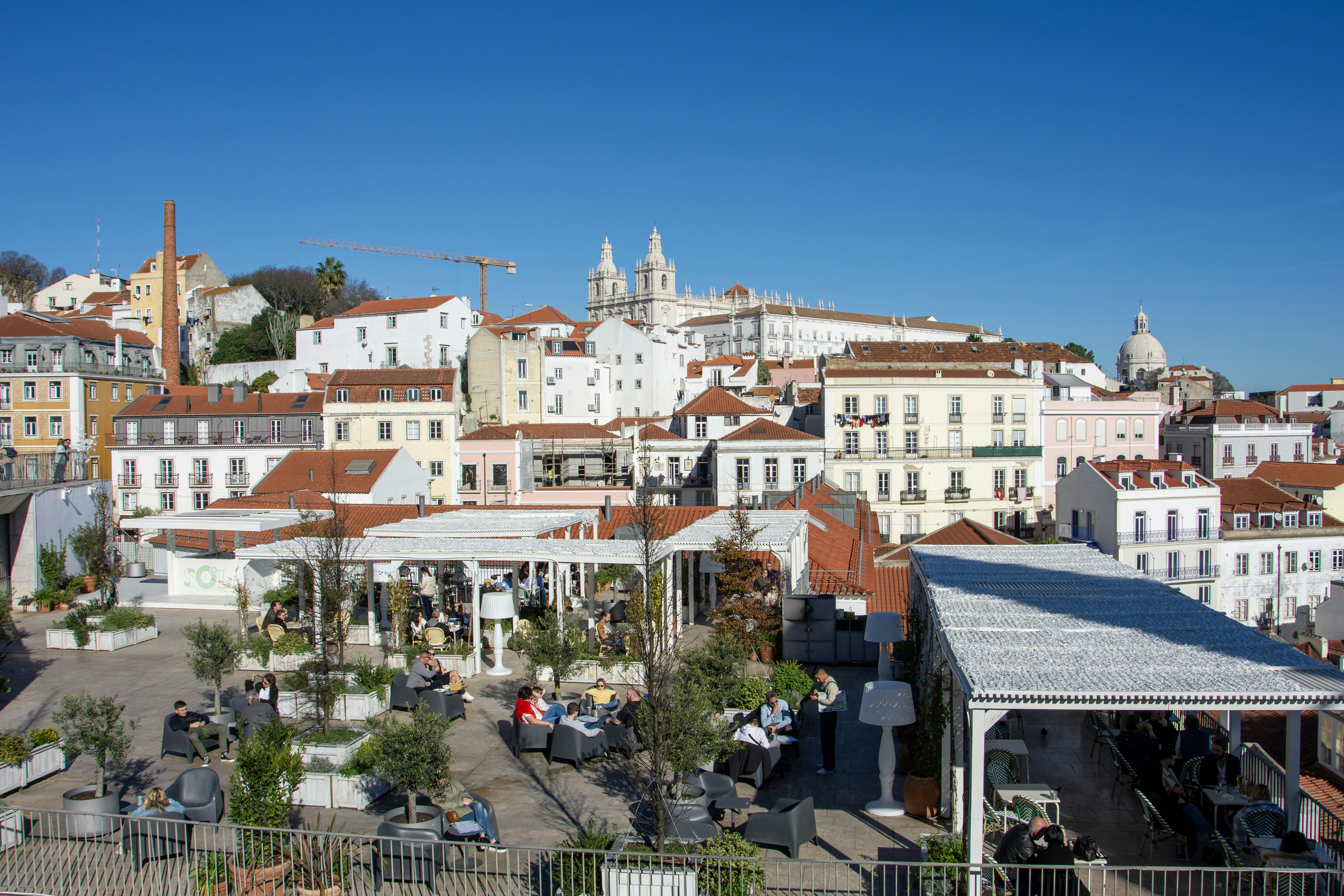 Terraced Alfama Caféscape Under a Clear Blue Sky