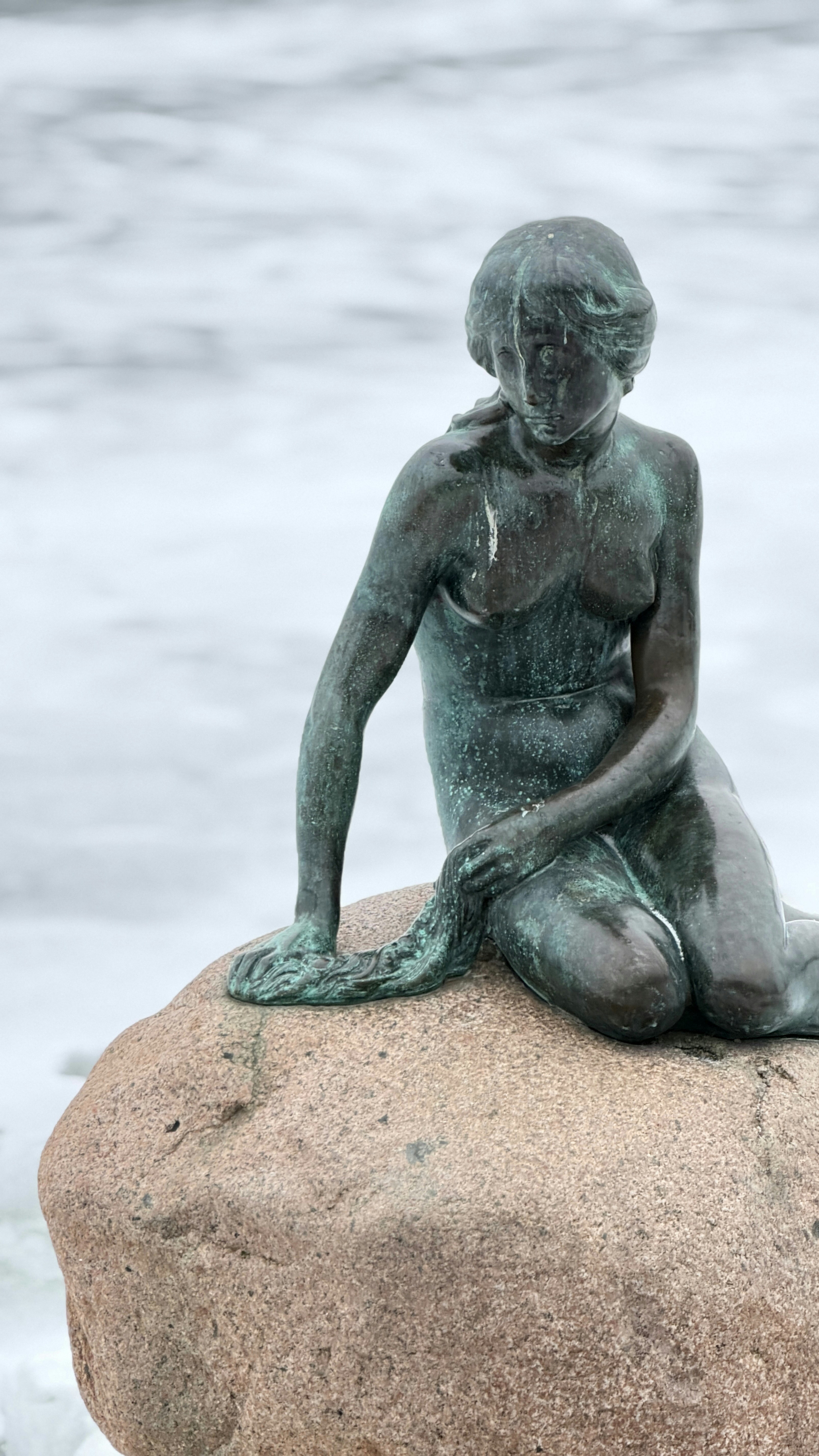 Little mermaid bronze sculpture winter iced over river Copenhagen Denmark