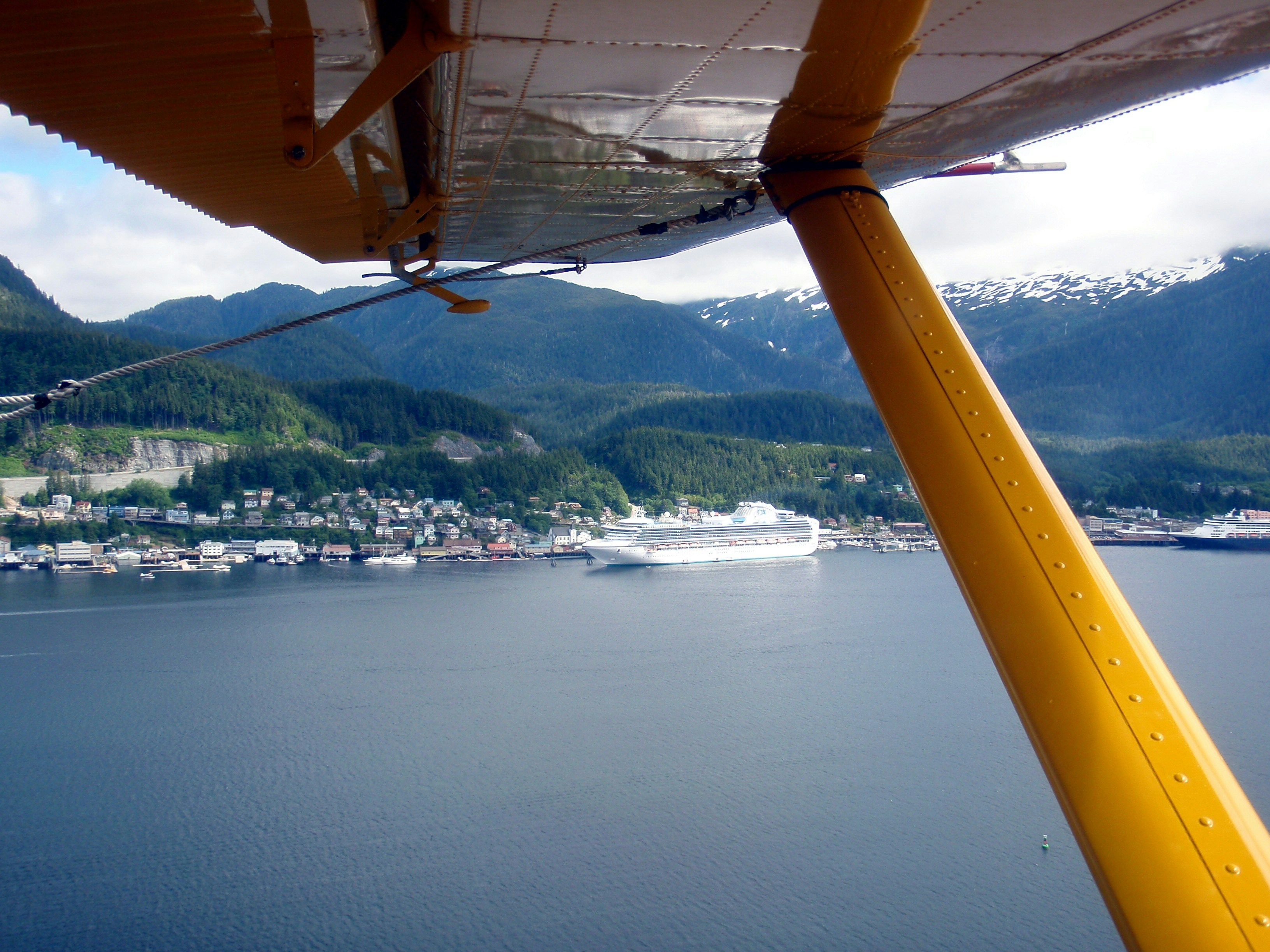 Winged Overlook: Mountains, Harbor, and a Cruise