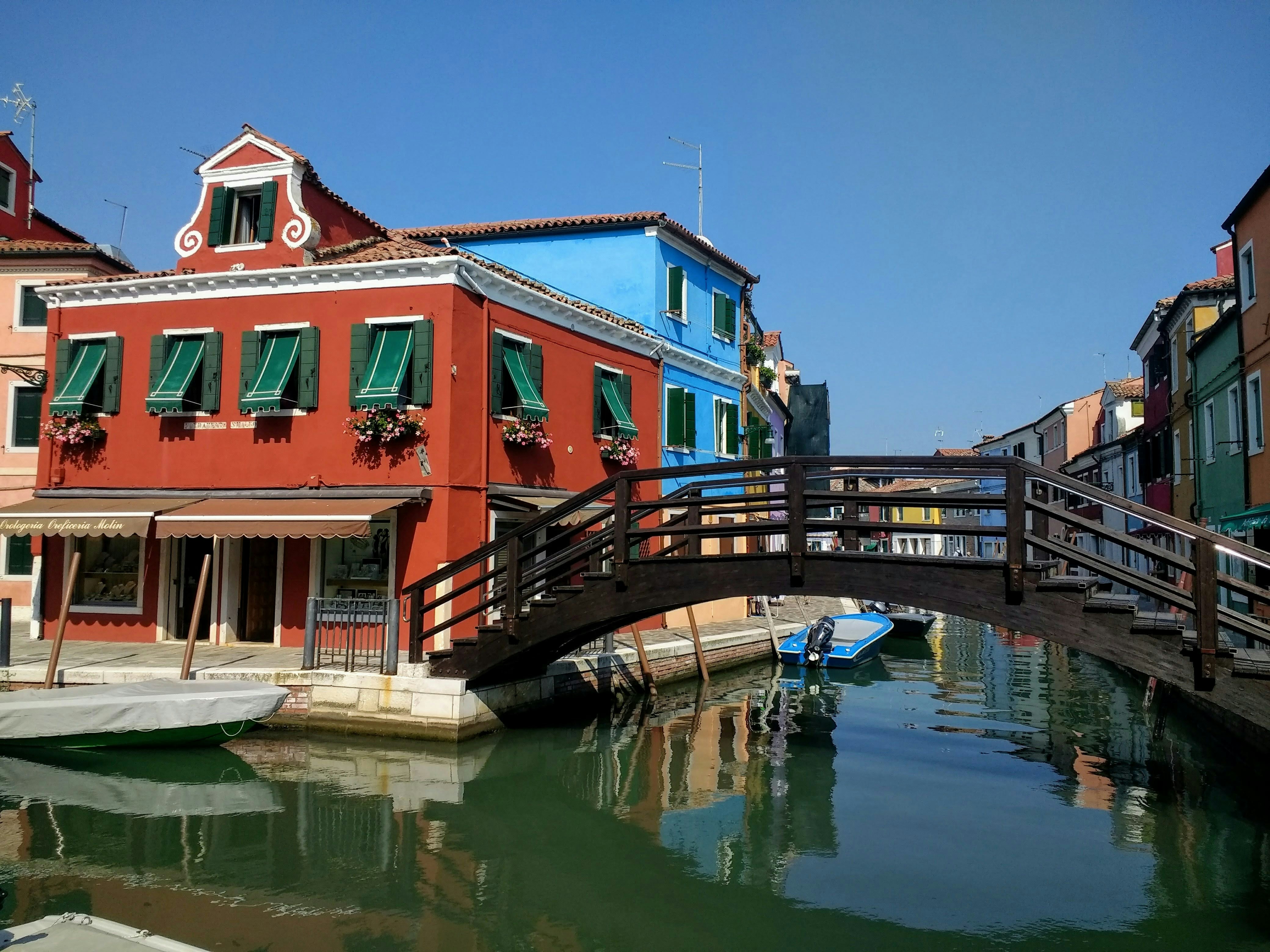 Vibrant canal bend: a sunlit Venetian-inspired streetscape