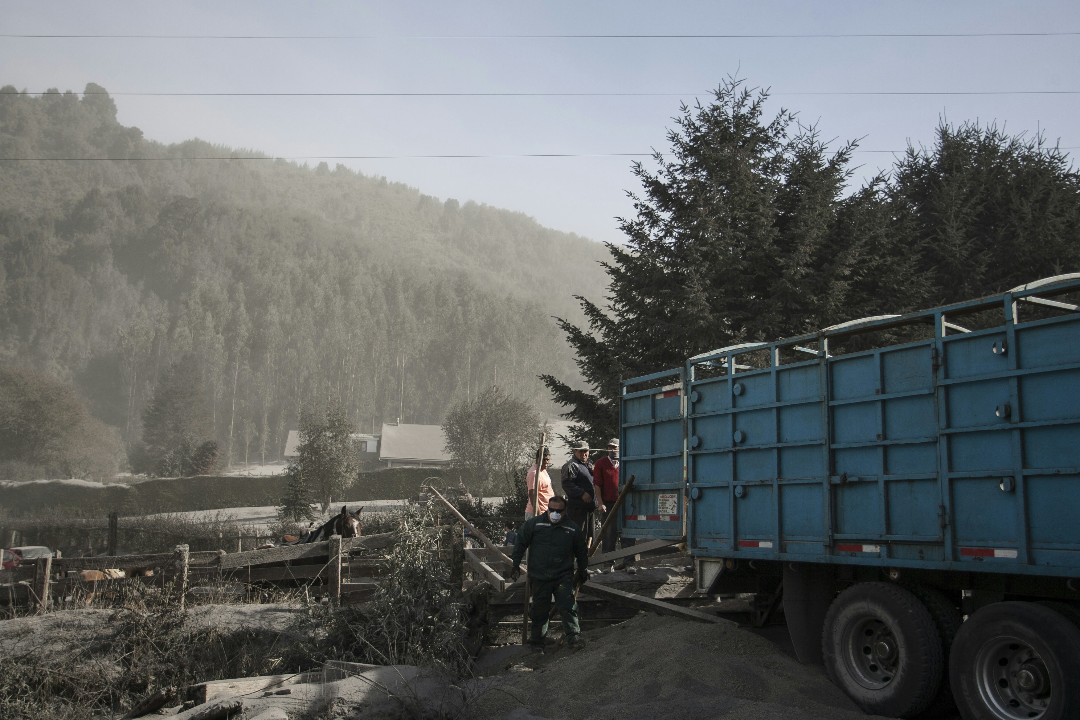 Dust, Tracked: Workers and a Blue Truck at a Rural Quarry
