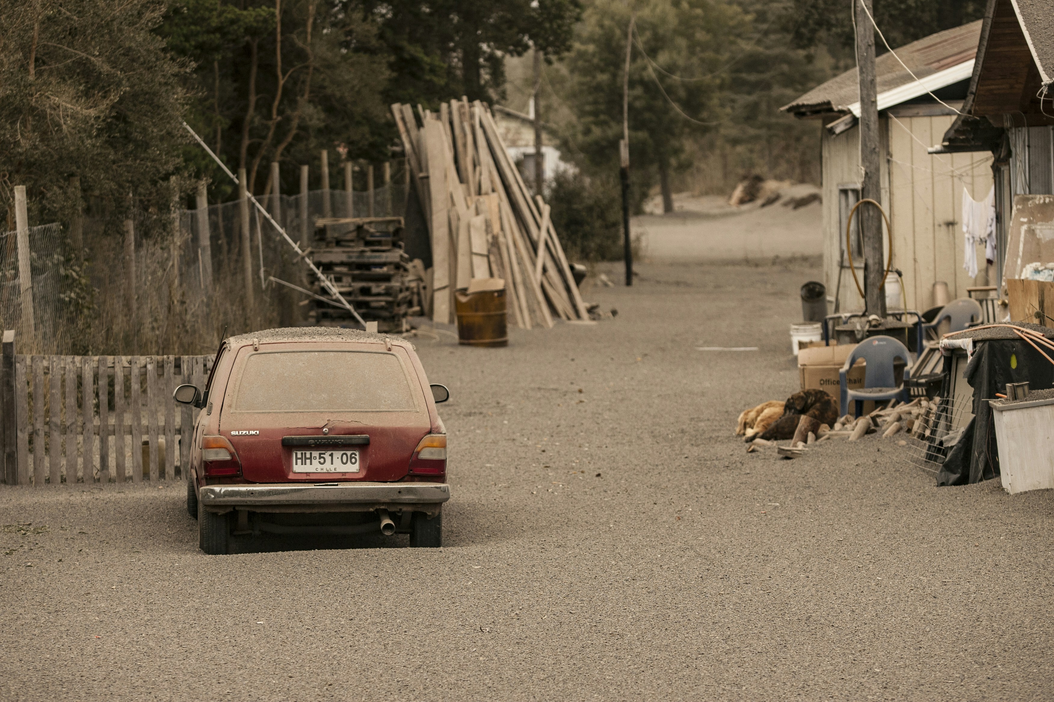 Dusty Roadyard Portrait: A Red Car and Cluttered Linear Quiet