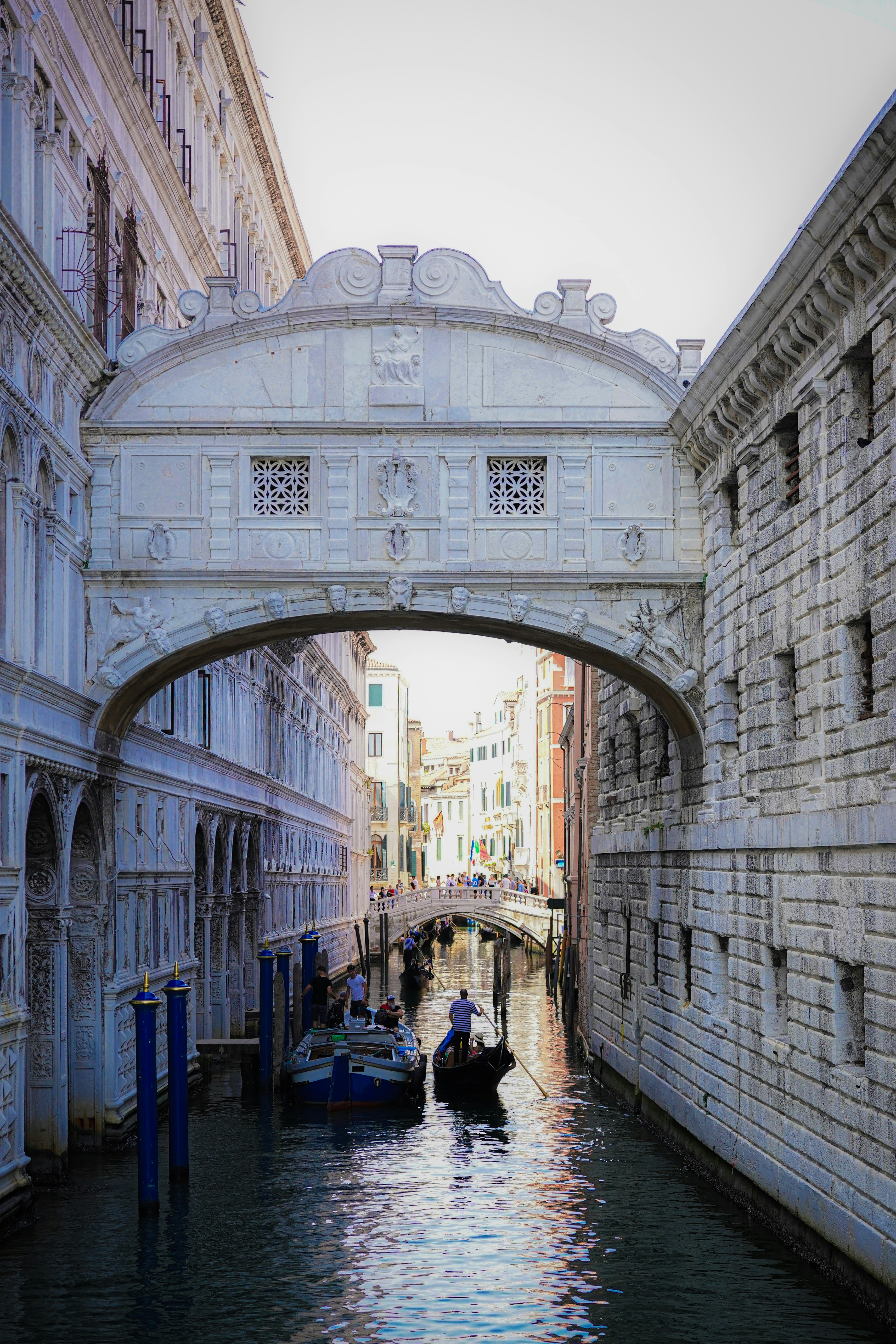 Gondolas pass under the bridge of sighs in venice.