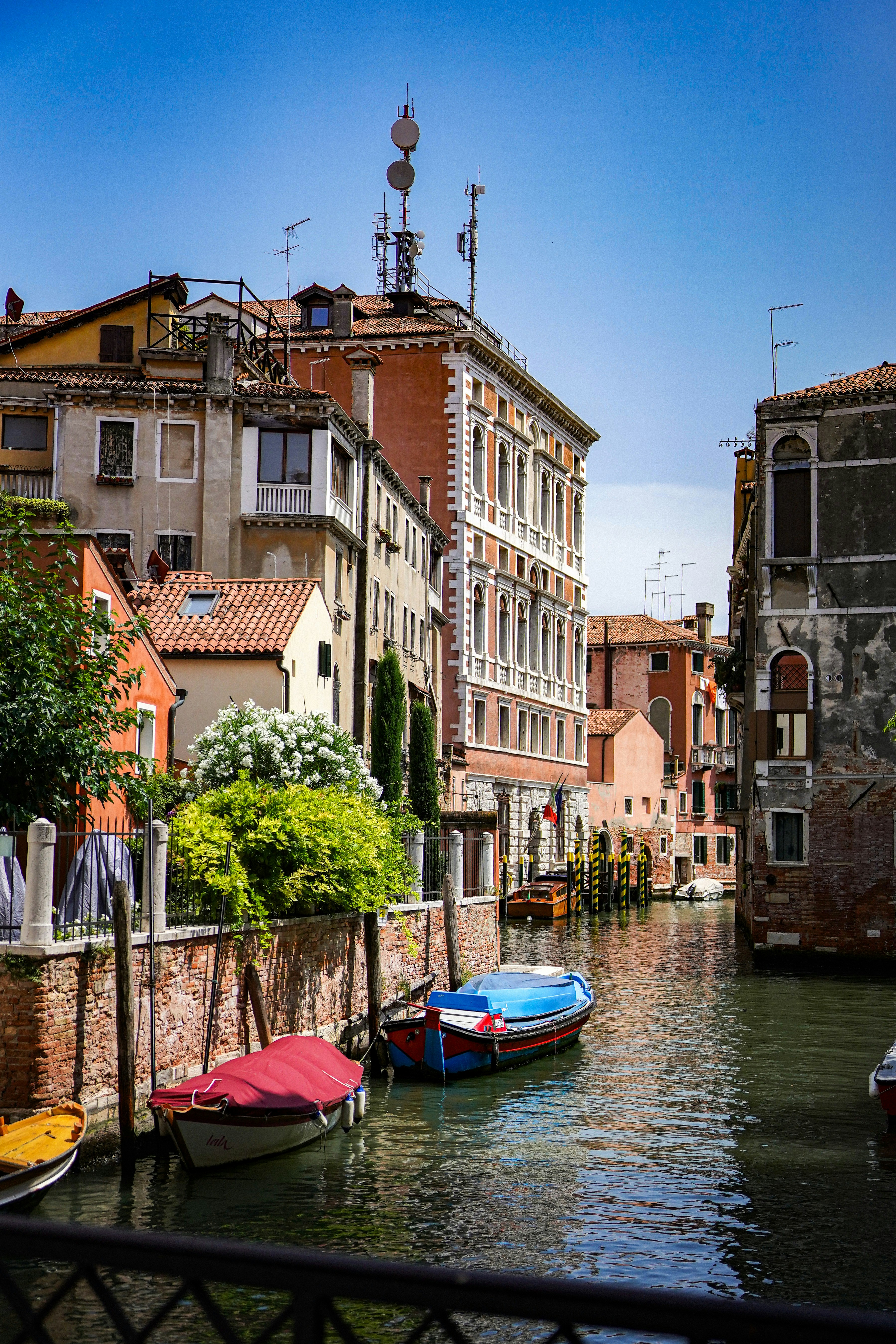 Sunlit Venetian Canal Fronting Buildings and Boats