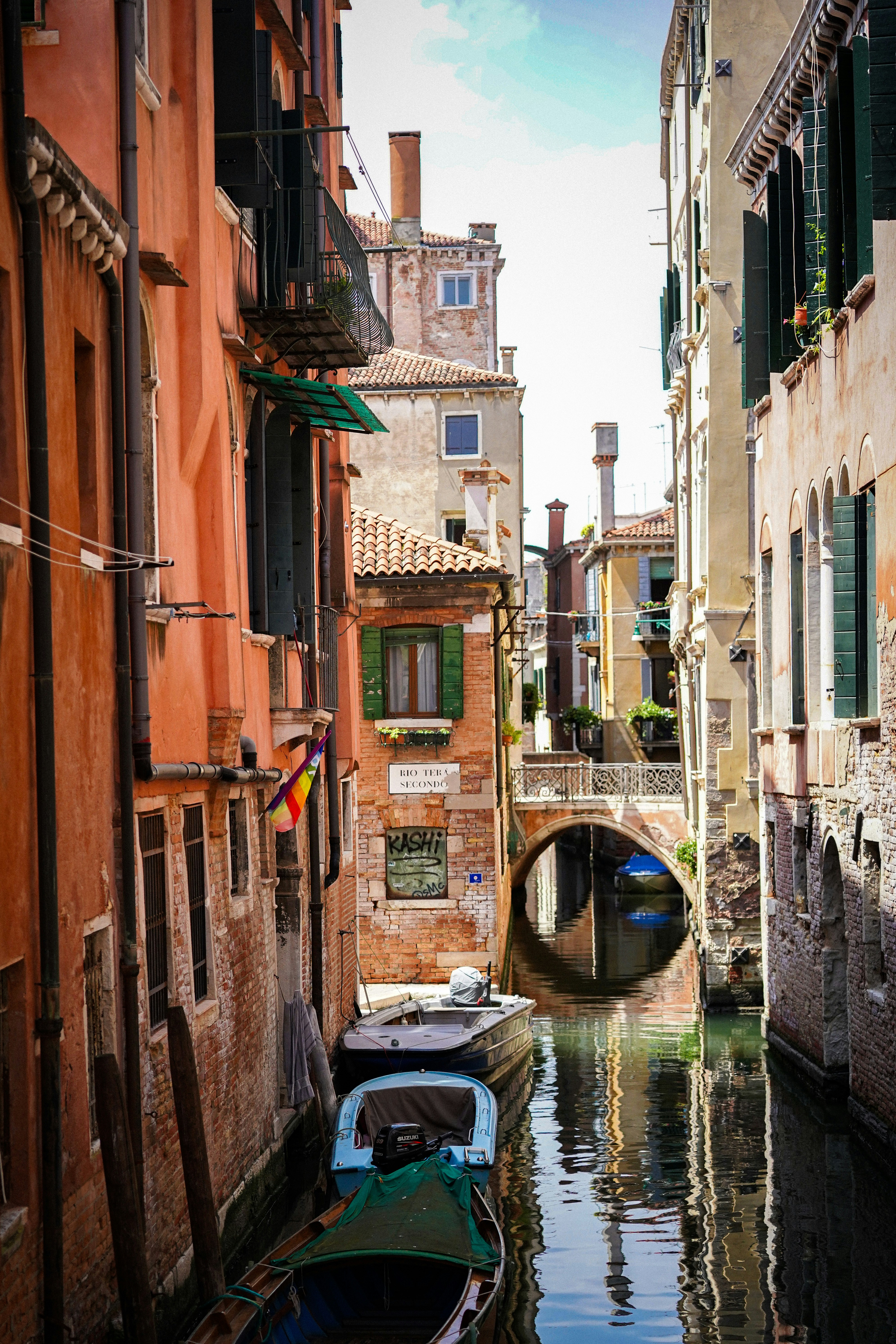 Canal Corridor Between Sunlit Facades in a Venetian Alley