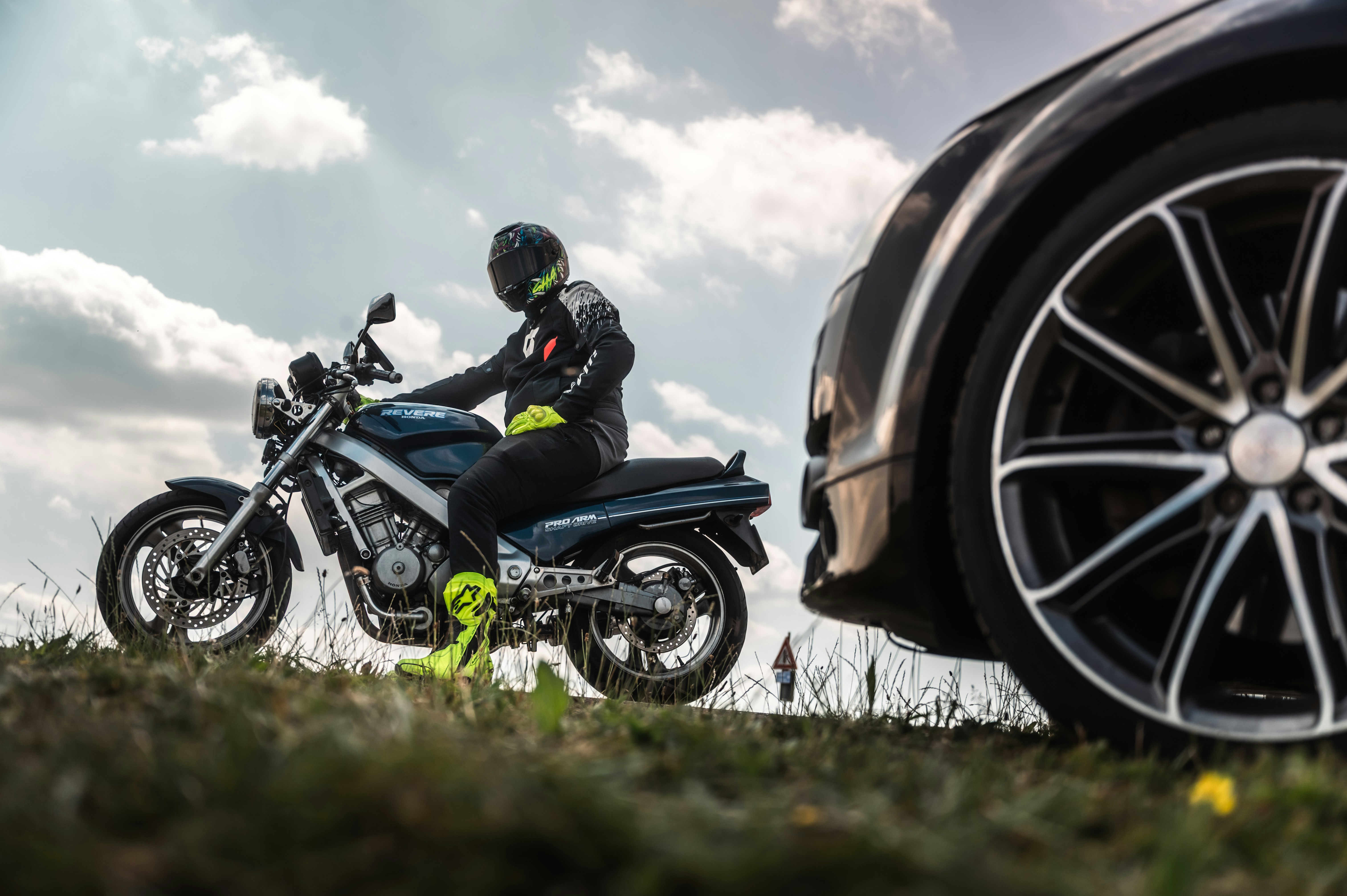 Rider and Moto in Ground-Level Perspective under Open Sky