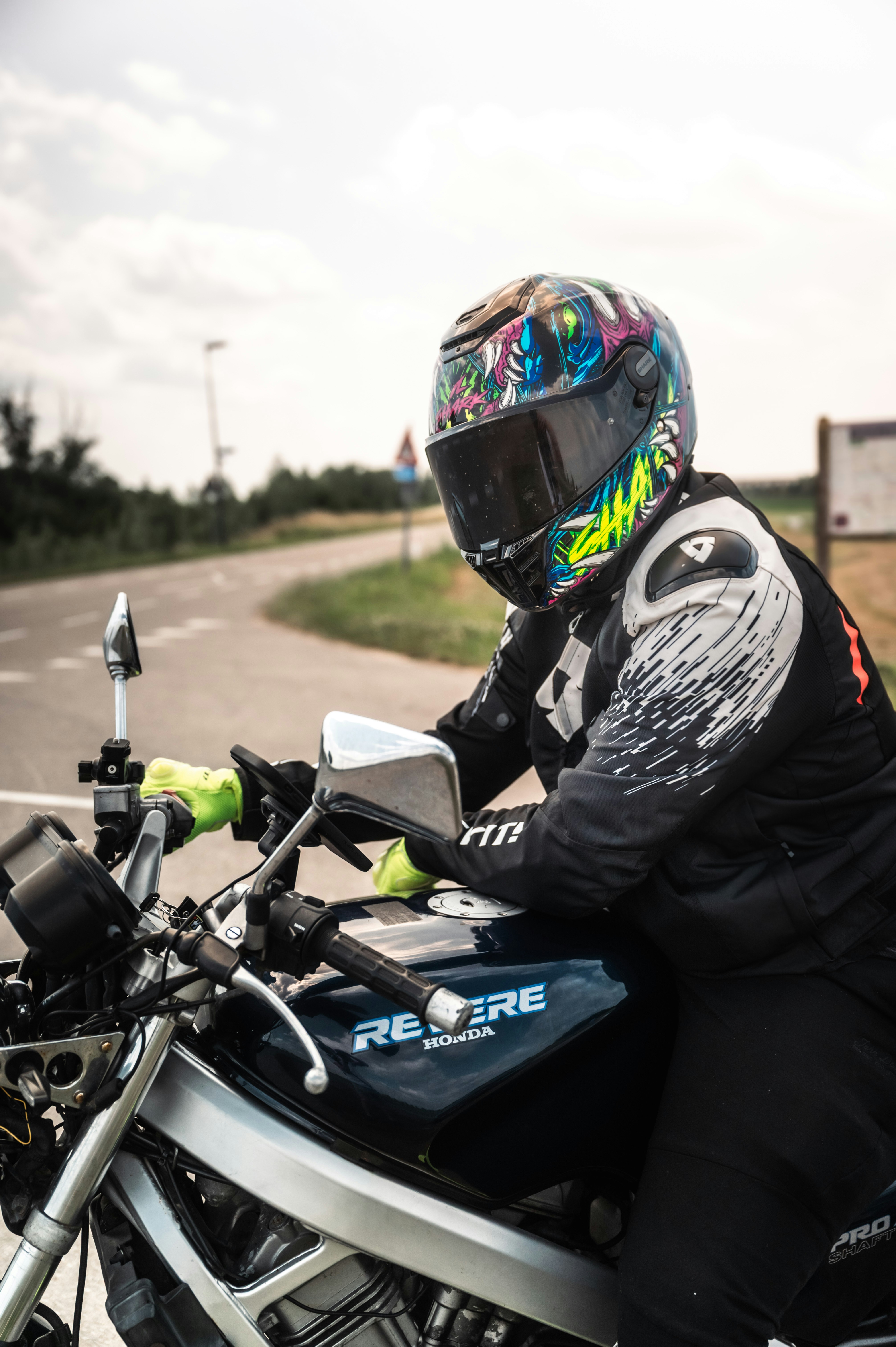 Colorful Helmeted Rider on a Refinished Honda Streetbike