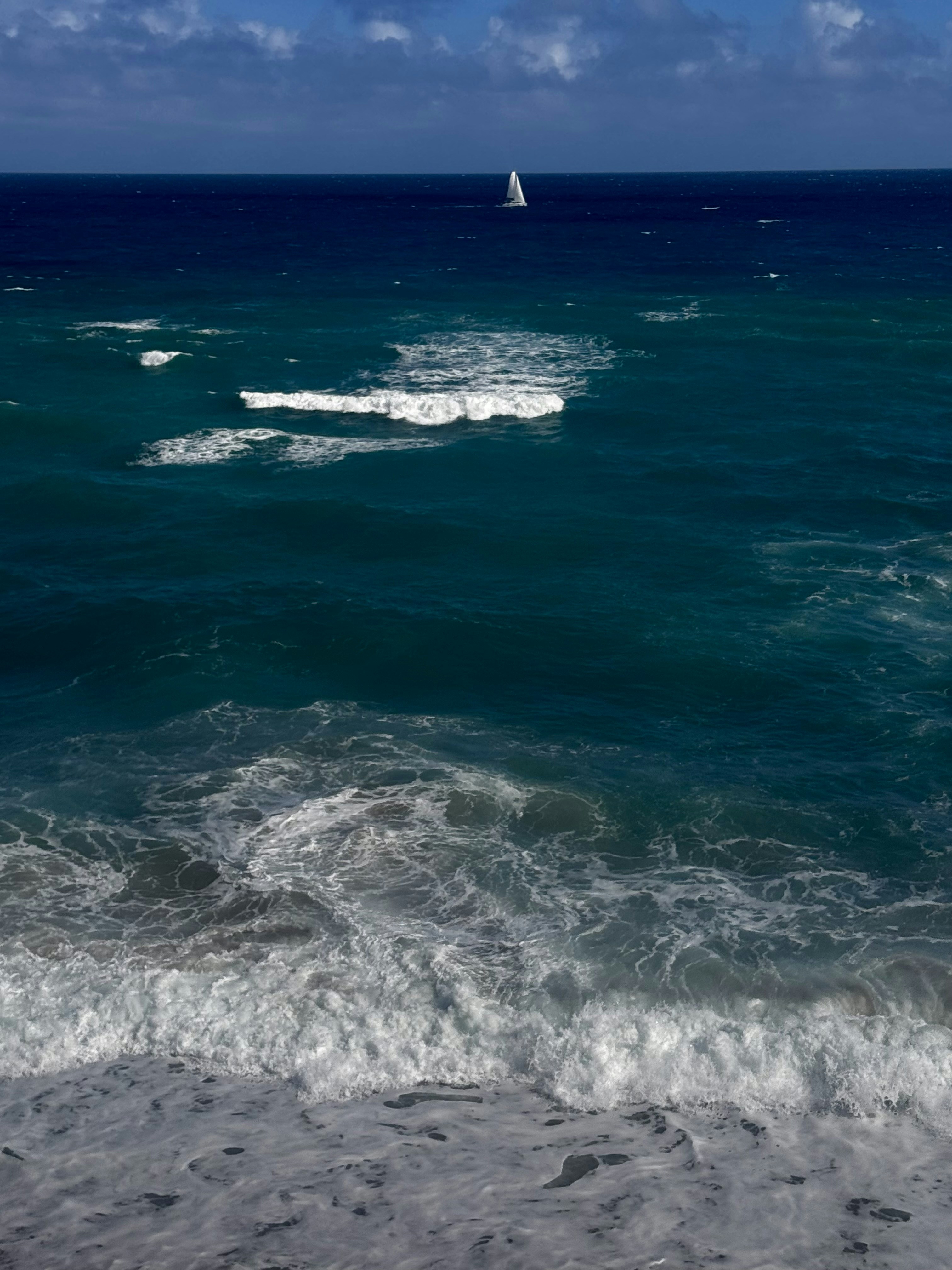 Sailboat on a Midday Ocean Ridge