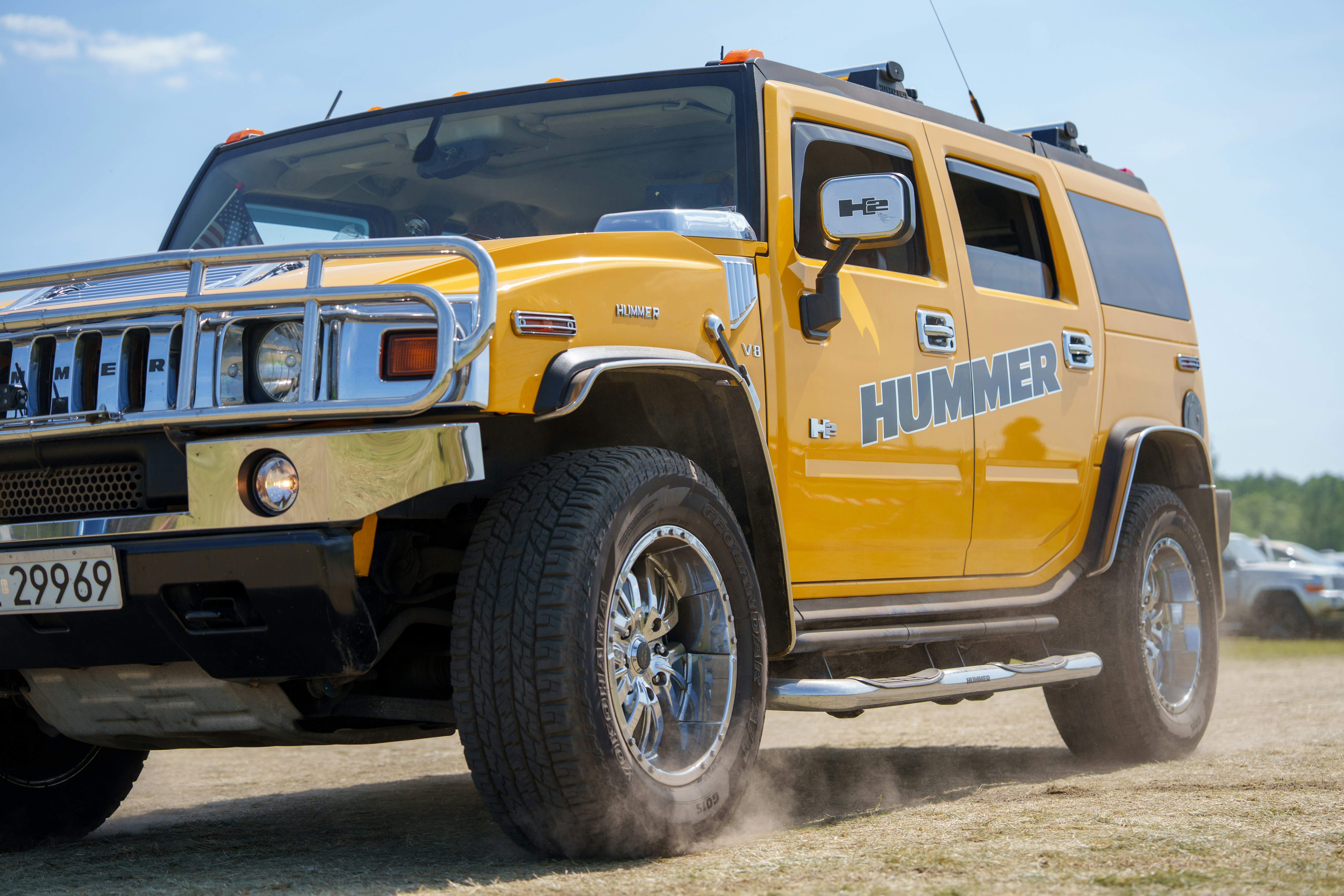 Hummer in Motion: Dust Throws Up Beneath a Sunlit Desert Sky
