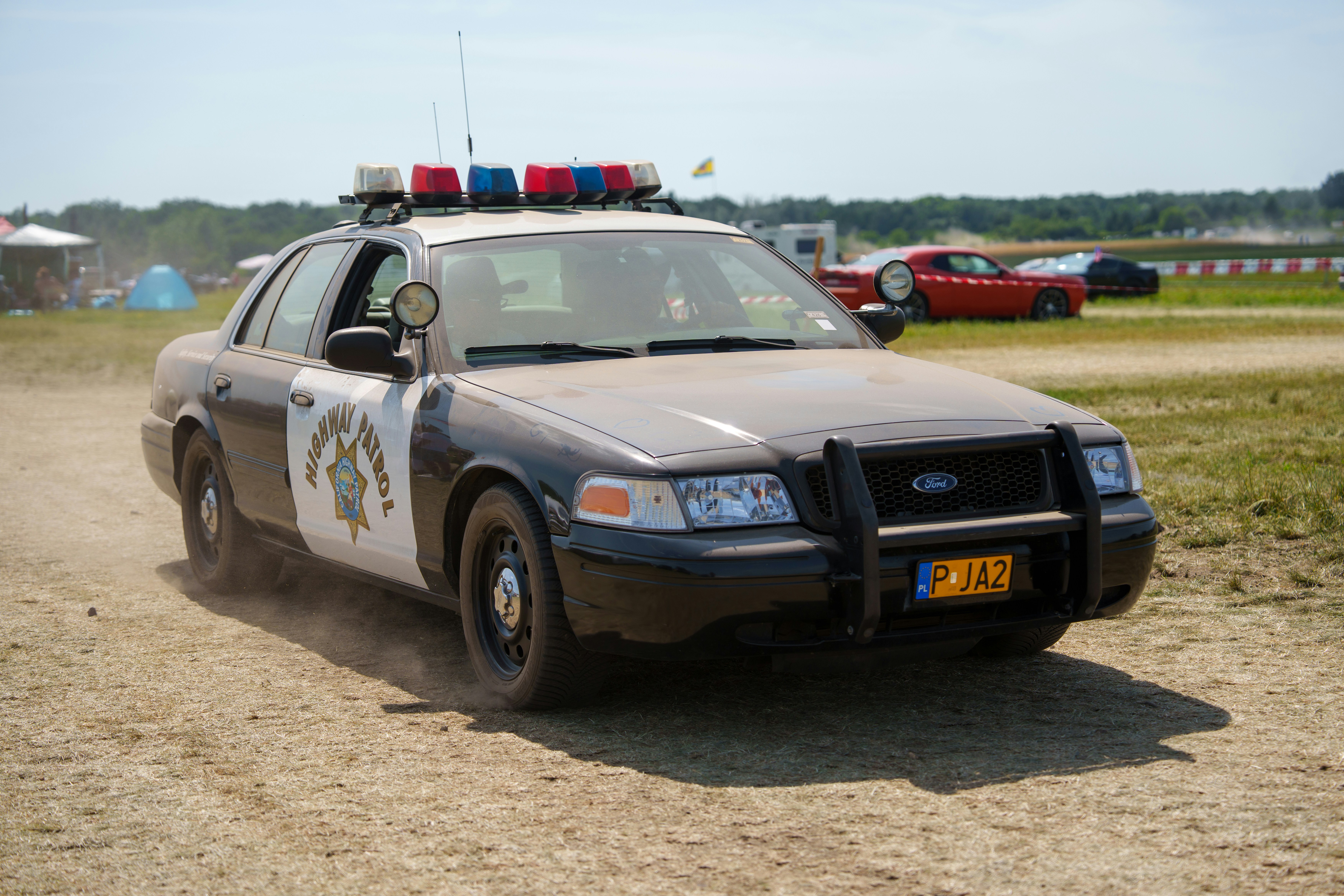 Patrol Power: Coastal Beacon Police Car Rounds a Dusty Field
