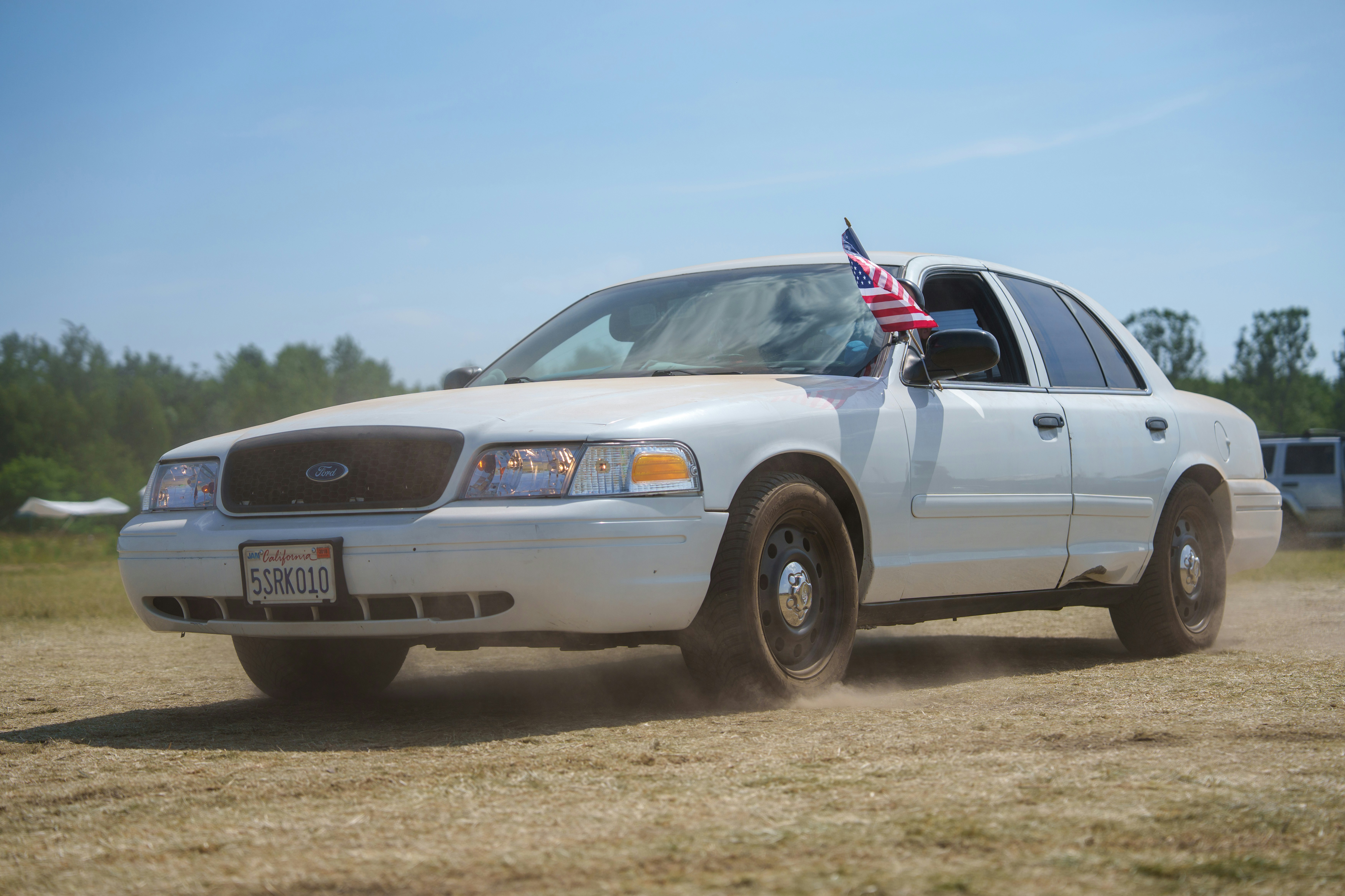 Patriotic Sedan on Dusty Runway